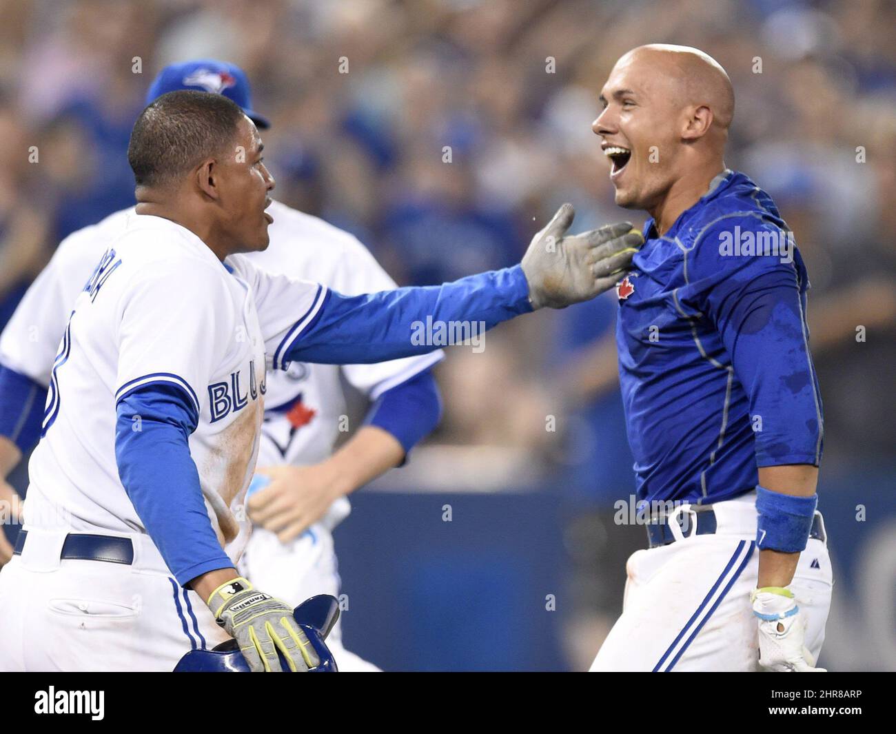 Toronto Blue Jays' Ryan Goins, right, celebrates his walk off home run ...