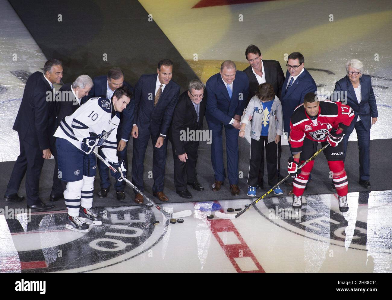 The official face-off at the first ever hockey game at the Videotron ...