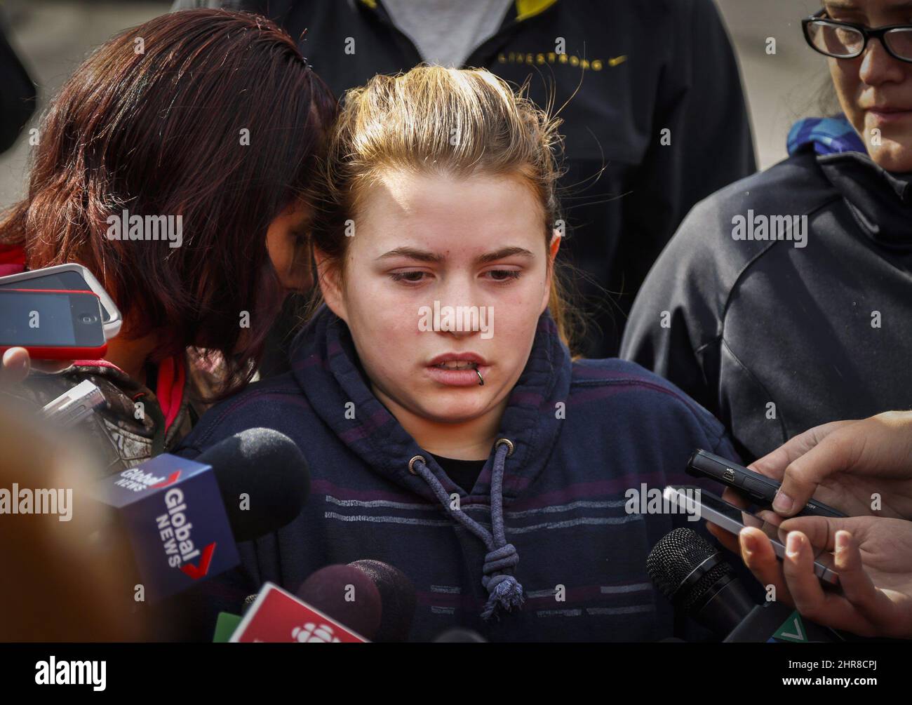 Cheyenne Dunbar, centre, is comforted as she speaks to the media about ...