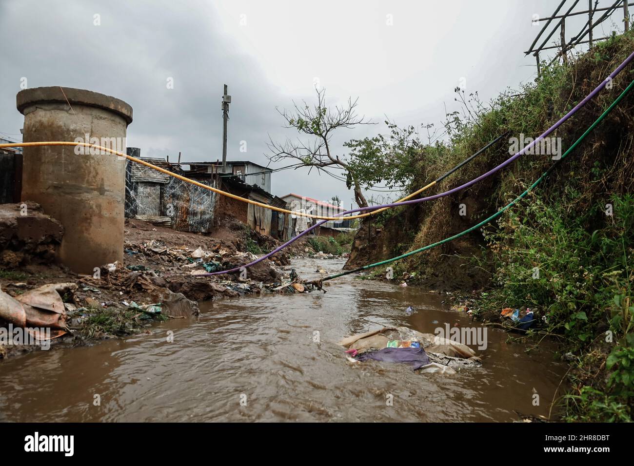 A river chocked with plastics and human waste runs alongside the houses ...