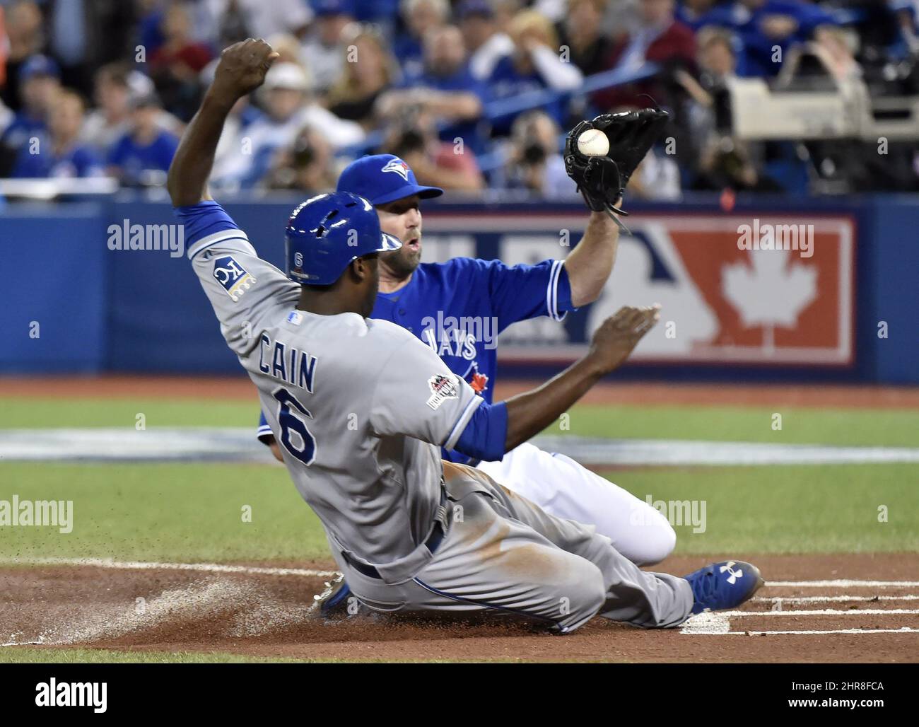Kansas City Royals' Lorenzo Cain, left, scores on a passed ball past ...