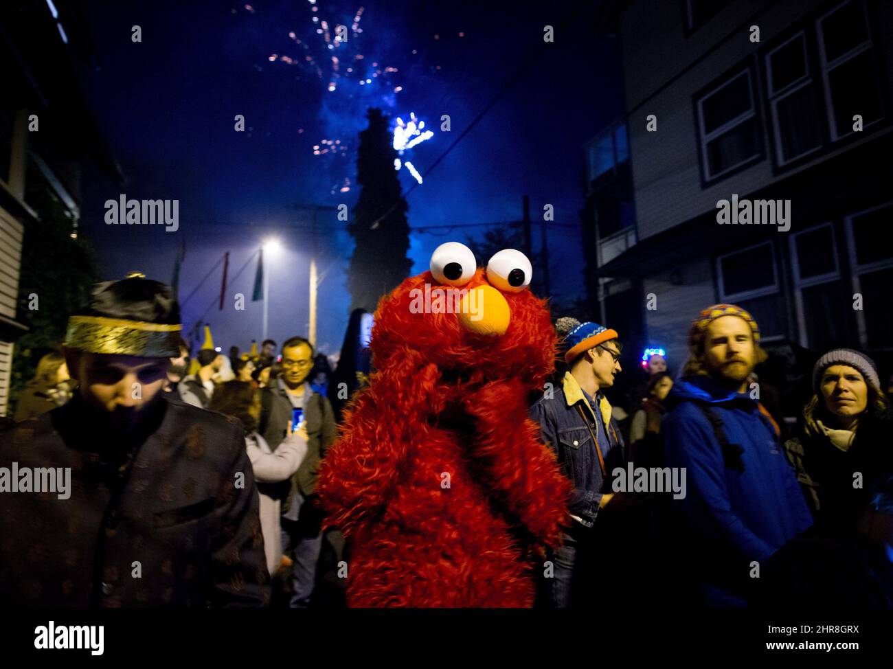 A man dressed as the Sesame Street character 'Elmo' marches with others ...