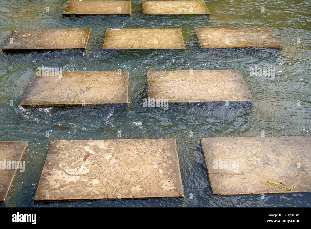 Shot of granite piles in the water Stock Photo - Alamy