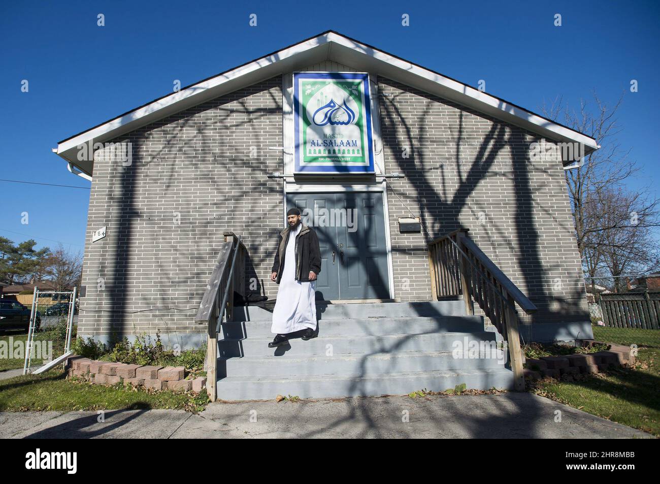 Imam Shazim Khan walks down the stairs at his mosque Masjid Al-Salaam ...
