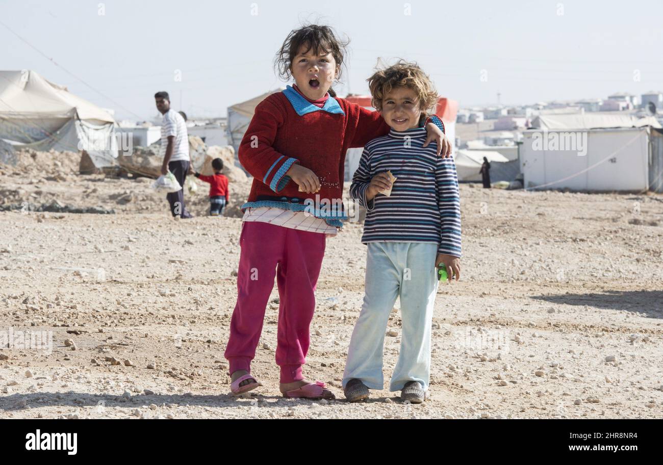 Two young Syrian refugee girls smiles for the camera in the Zaatari ...