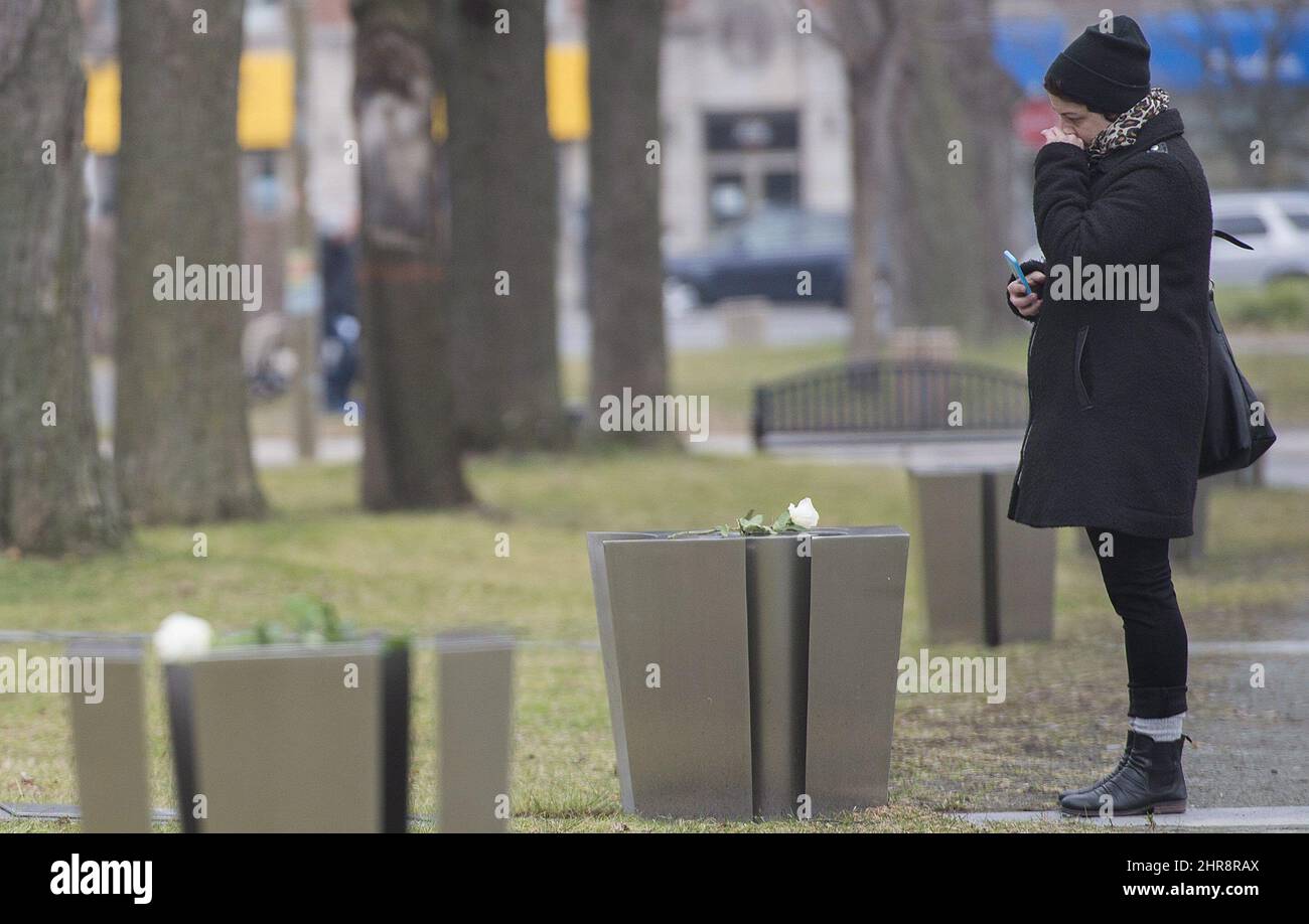 A woman stands next to a memorial of one of the fourteen women murdered ...