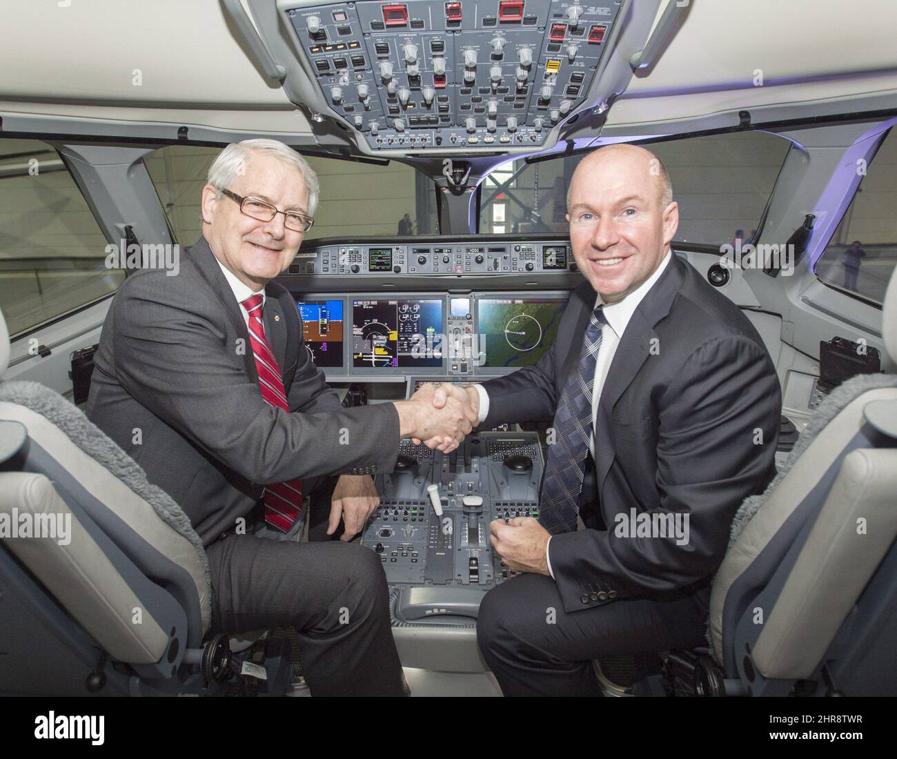 Bombardier chief executive Alain Bellemare, right, and federal ...