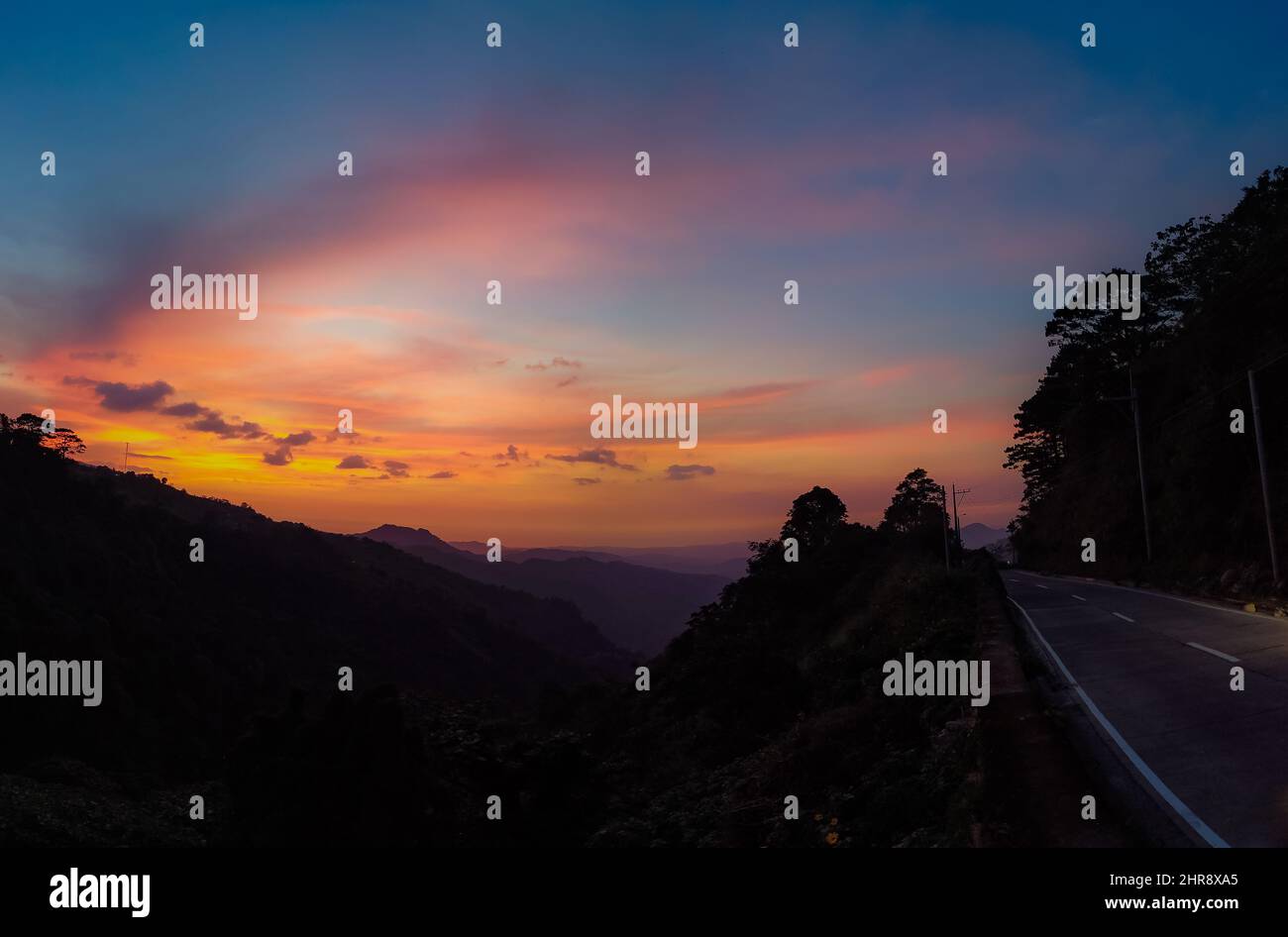 Empty highway road on the hillside with breathtaking sunset background ...