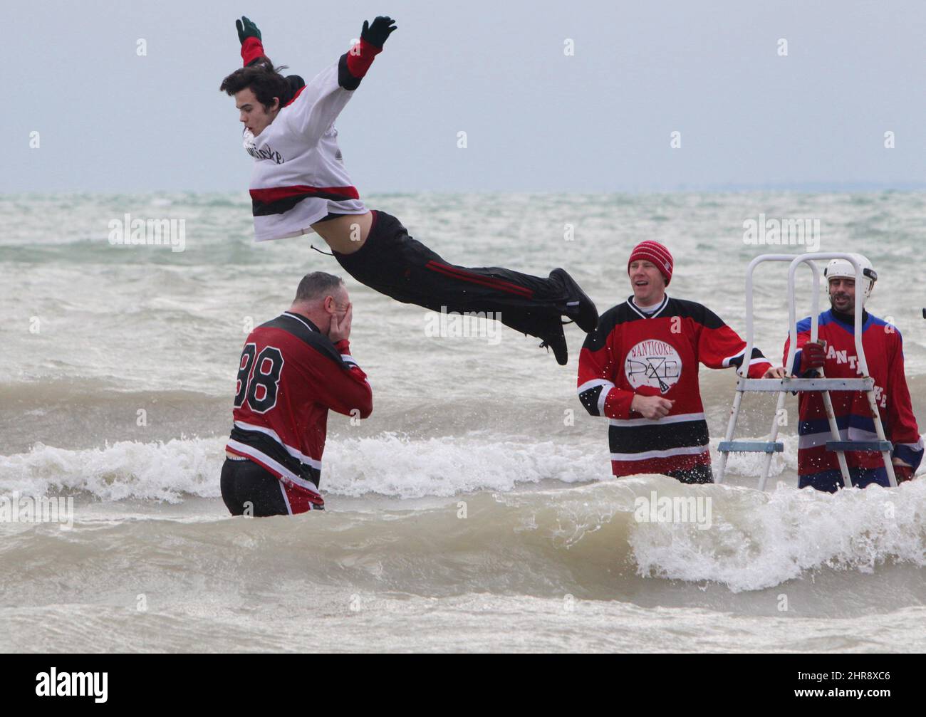 Revellers splash in Lake Erie during the New Year's Day Polar Bear Dip ...