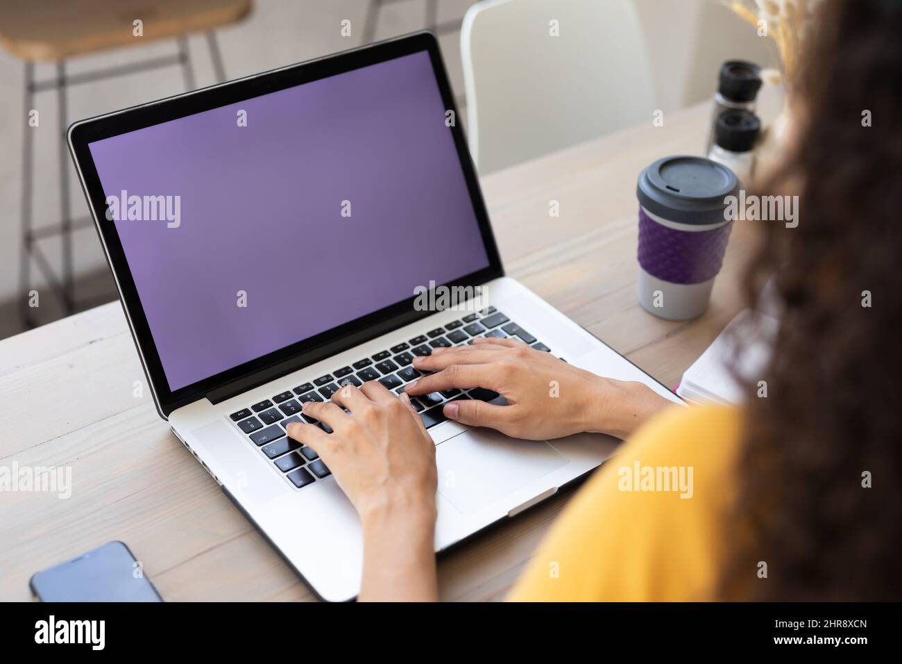 African american female customer using laptop with blank screen showing ...
