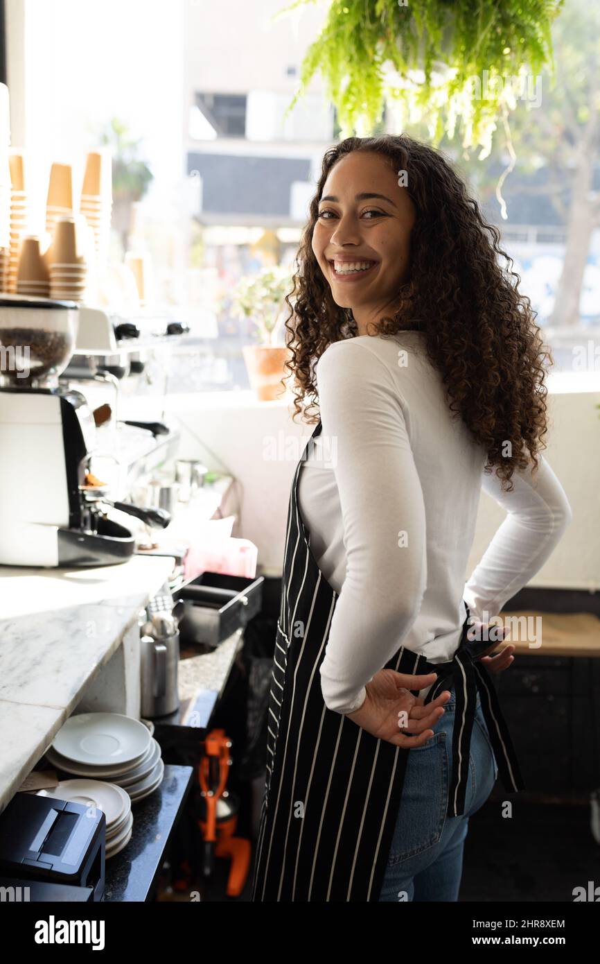 Portrait of smiling beautiful young african american barista wearing ...