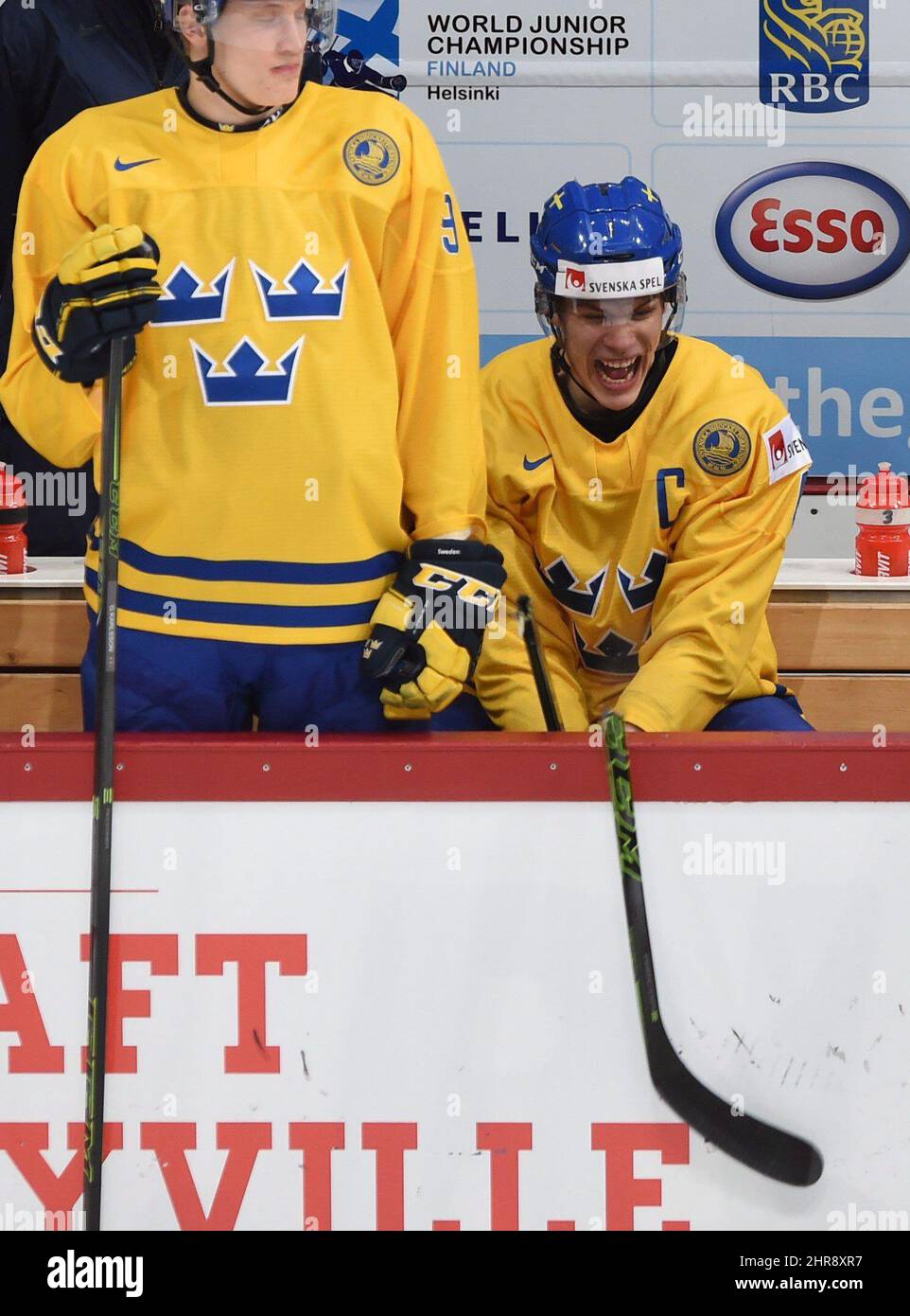 Sweden's captain Andreas Englund, right, breaks his stick over the ...