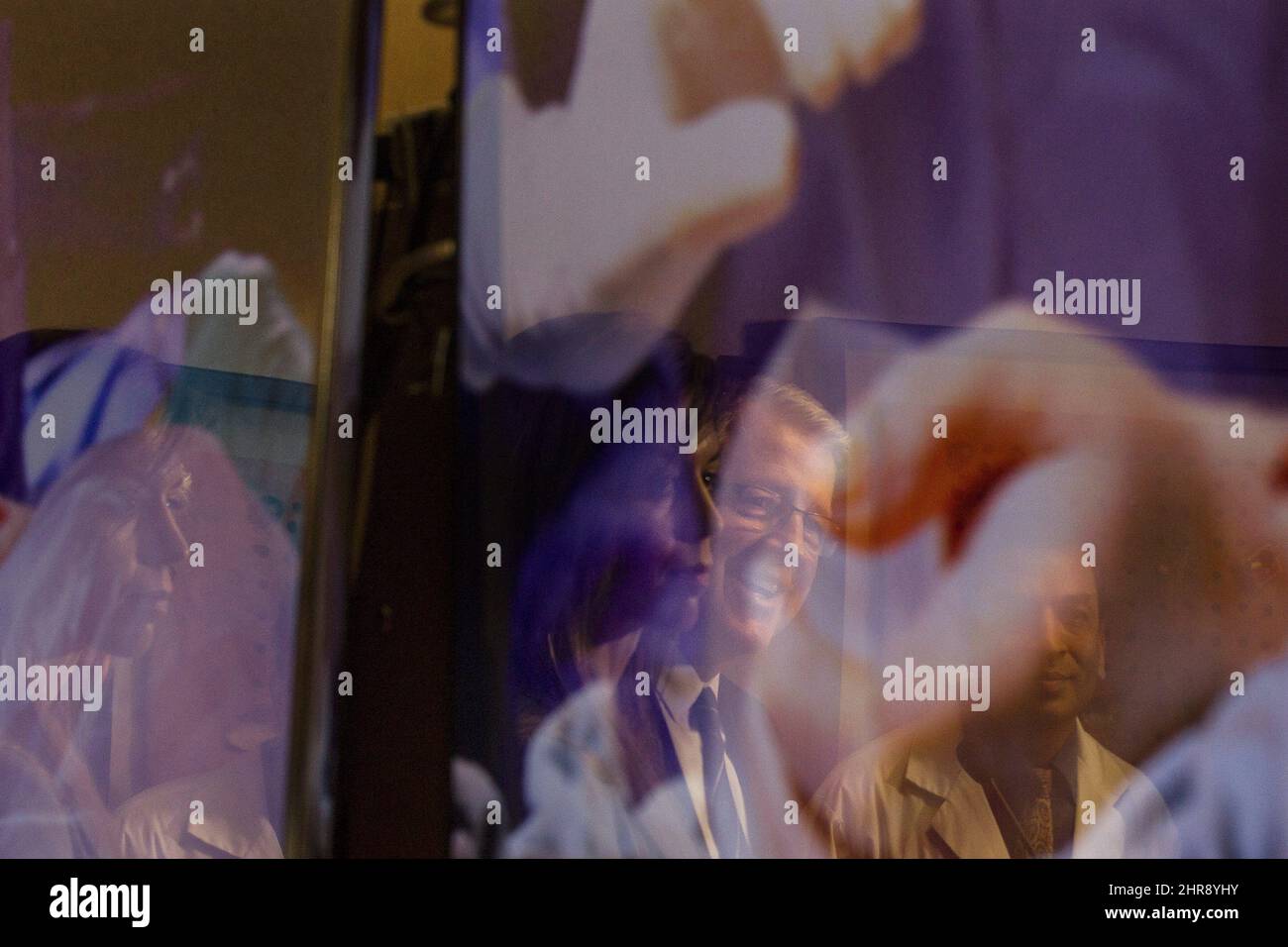 Dr. Steven McCabe, centre, is reflected in a screen showing an image ...
