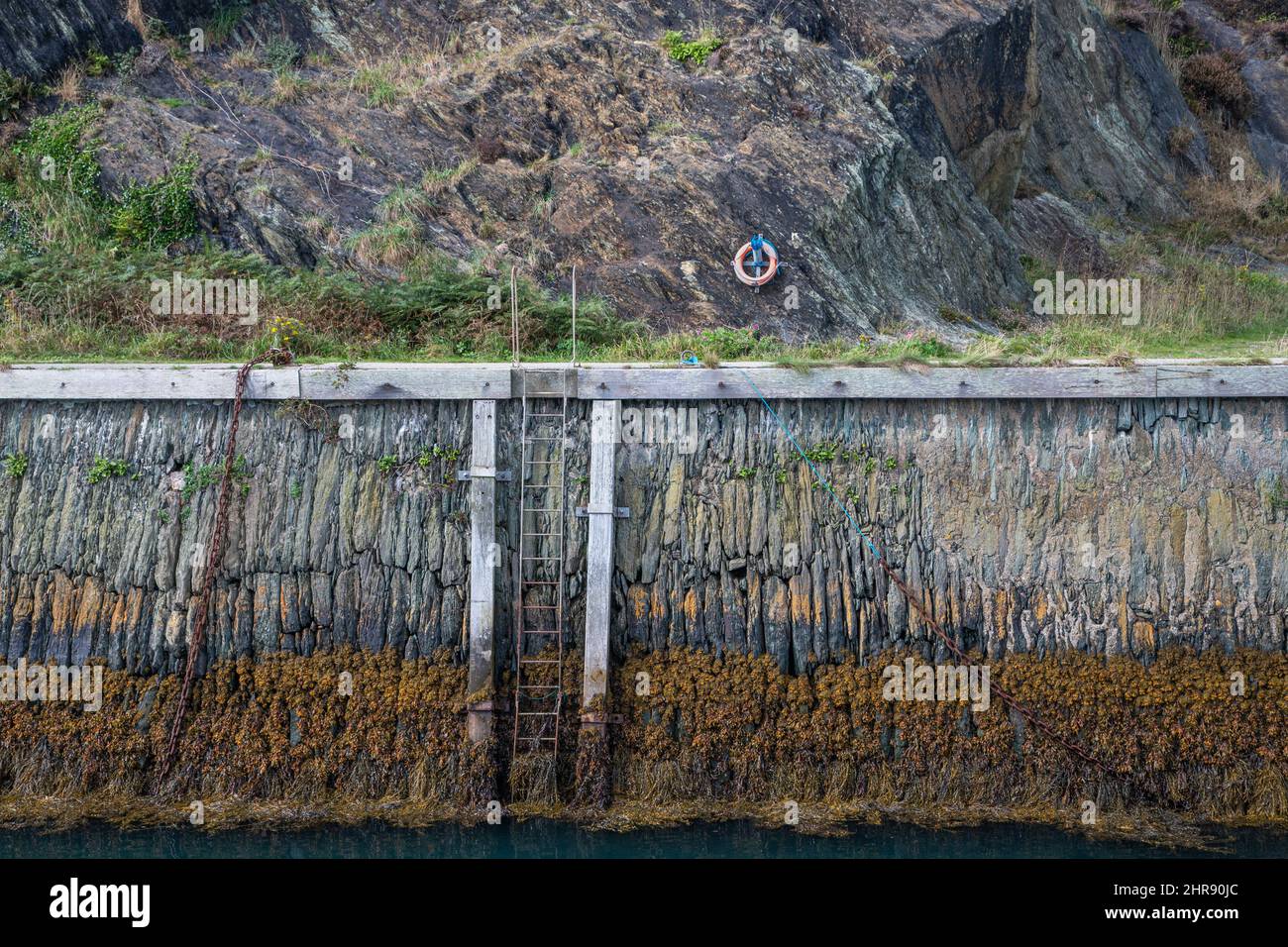 Vertivally aligned stone quay wall at Amlwch harbour Anglesey Stock ...