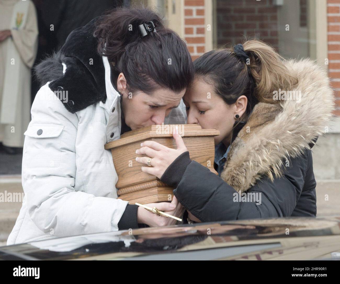The daughters of Daniel Dion, Valerie, left, and Marie-Michelle, kiss ...