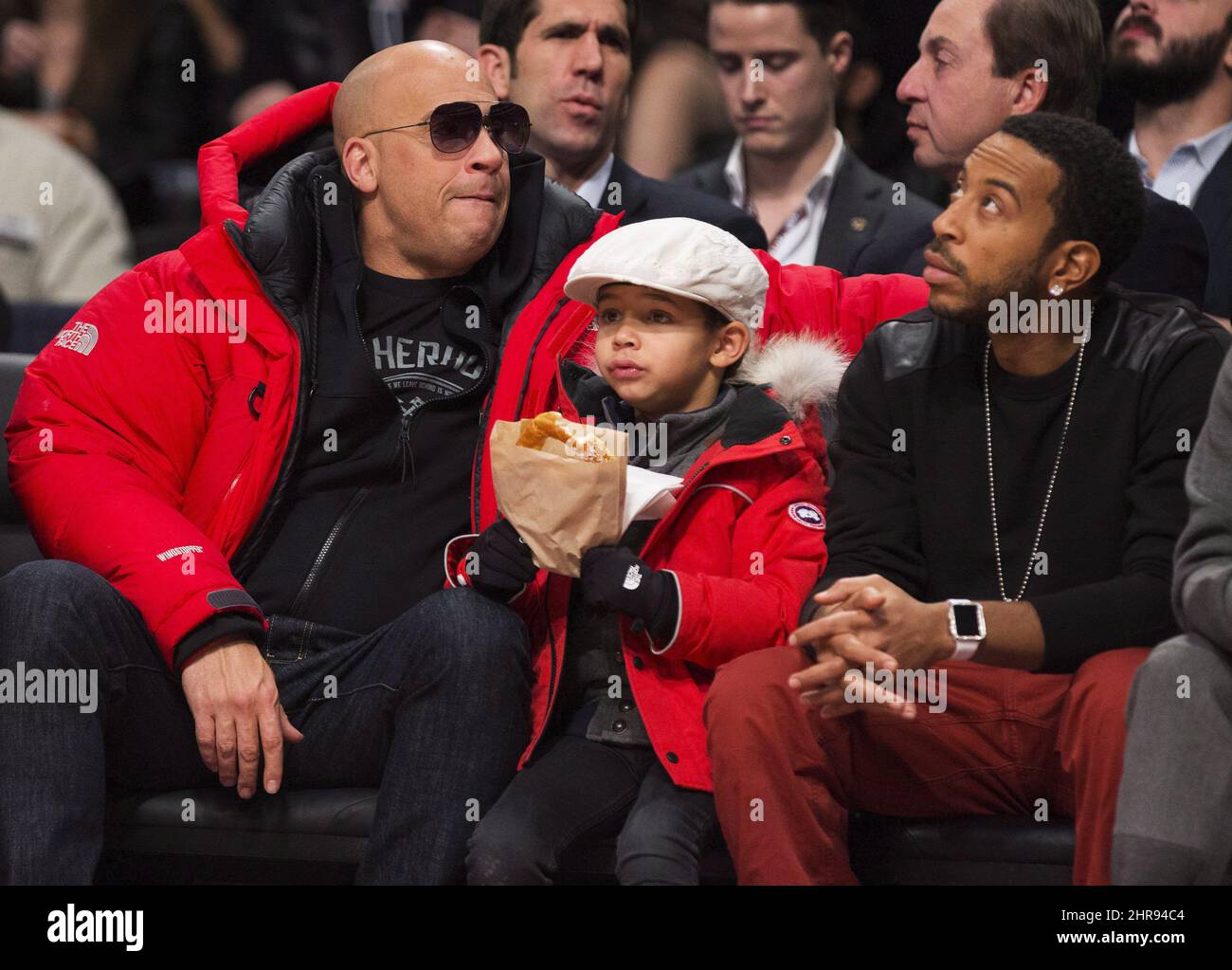 Actor Vin Diesel, left, and rapper Ludacris, right, watch from their ...