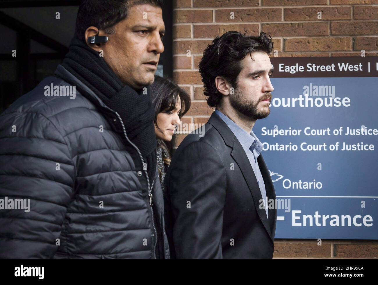 Marco Muzzo, right, leaves the Newmarket courthouse surrounded by ...