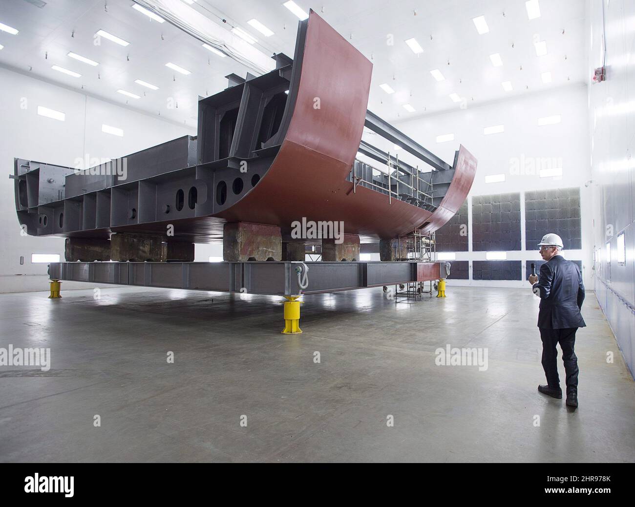 Kevin McCoy, president of Irving Shipbuilding, leads a tour as workers ...