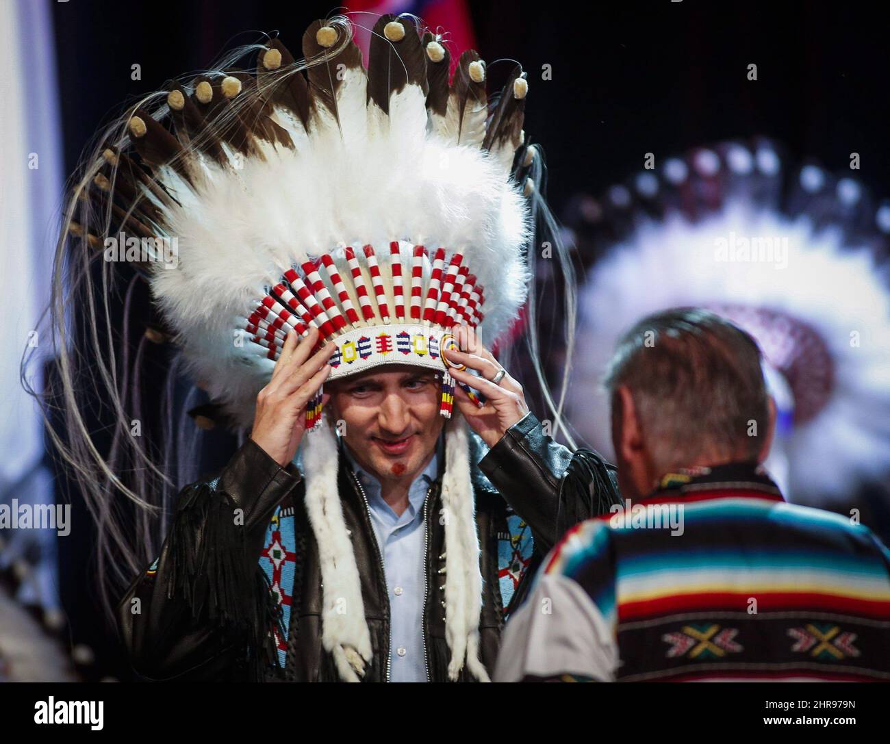 Prime Minister Justin Trudeau, left, adjusts his new headdress as Tom ...