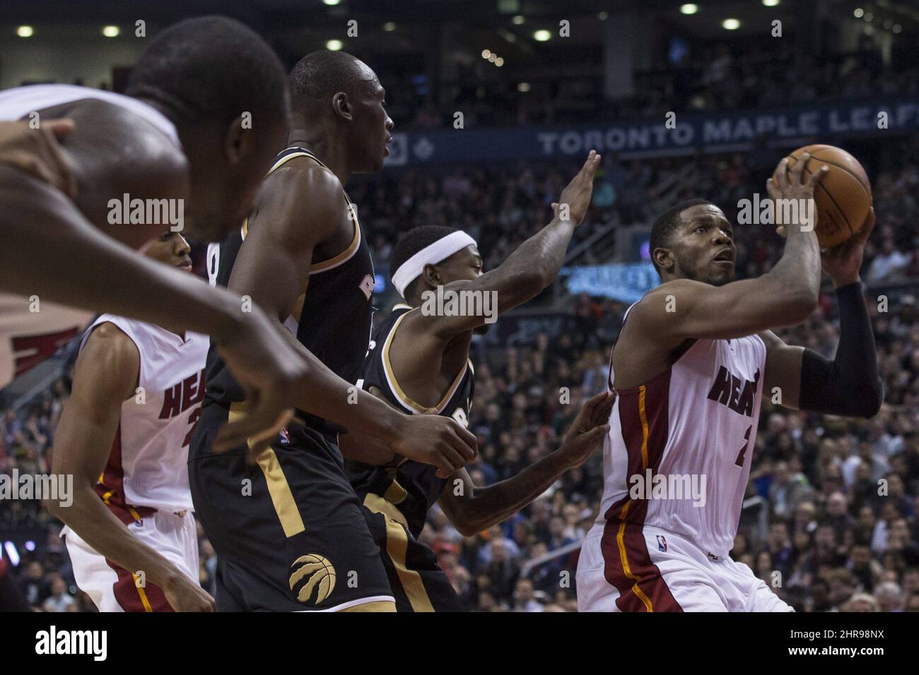 Miami Heat's Joe Johnson, right, shoots on the Toronto Raptors' defence ...