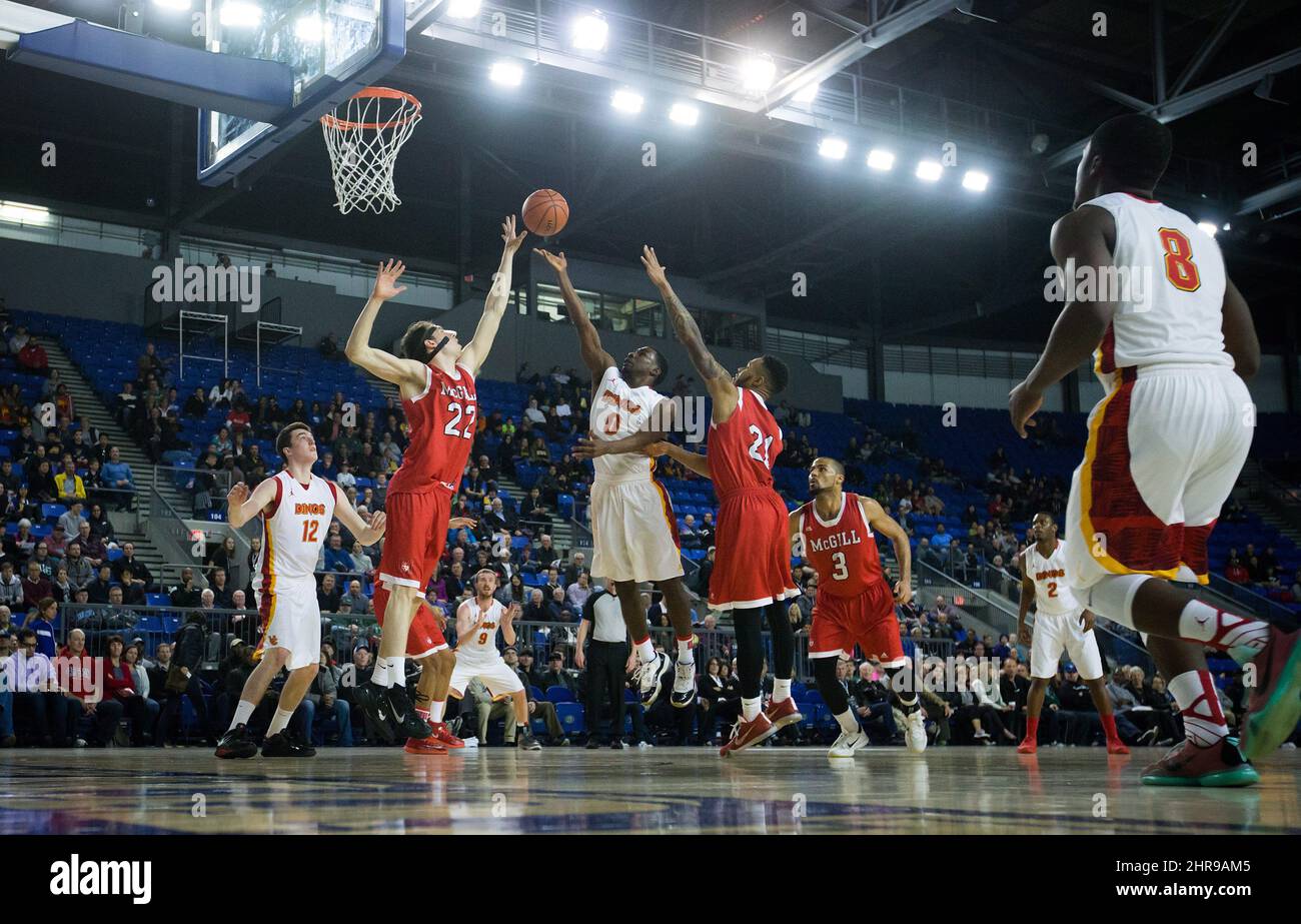 Calgary Dinos' David Kapinga (0) shoots over McGill Redmen's Francois ...