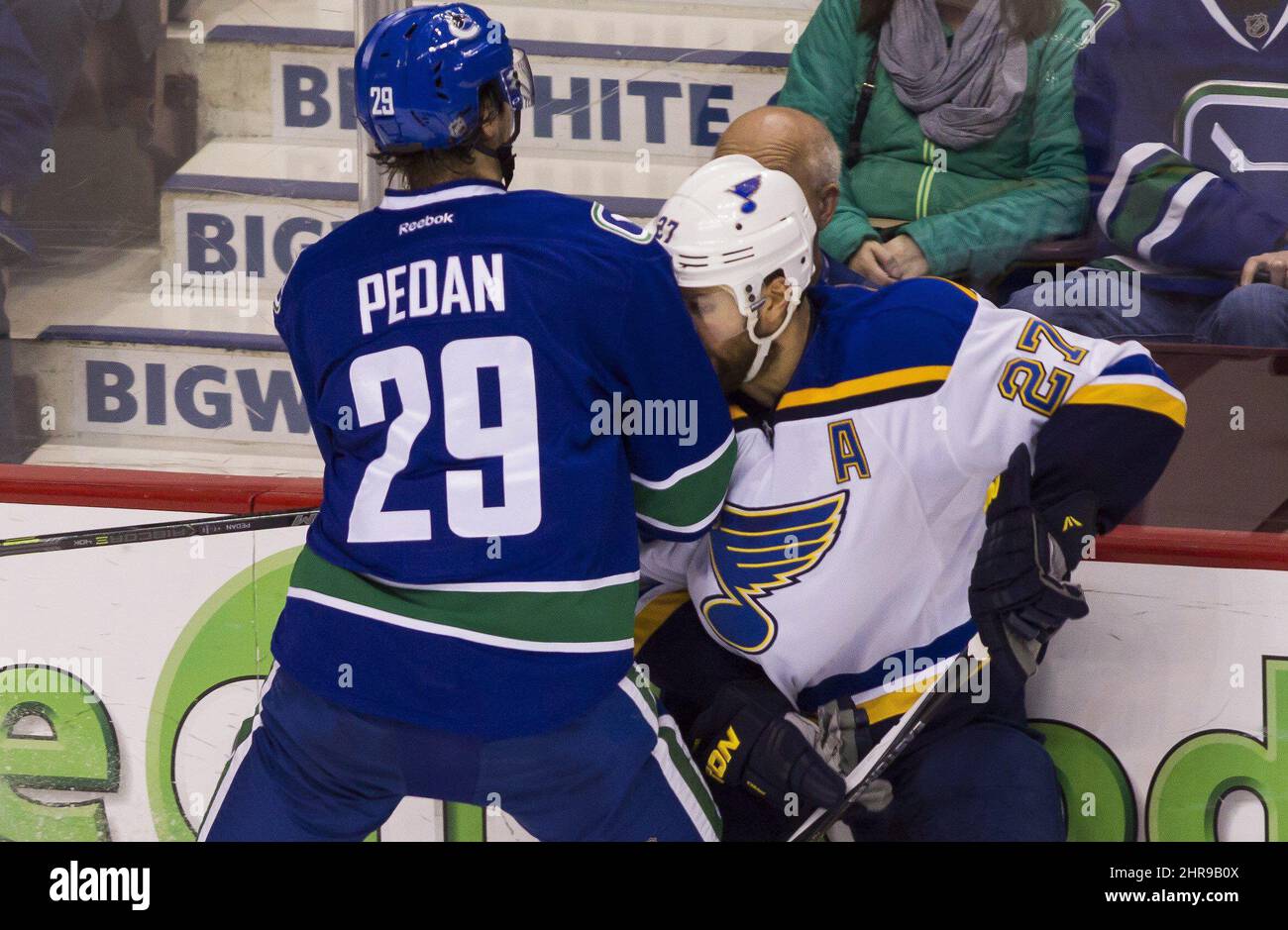 Vancouver Canucks' Andrey Pedan (29) checks St. Louis Blues' Alex ...