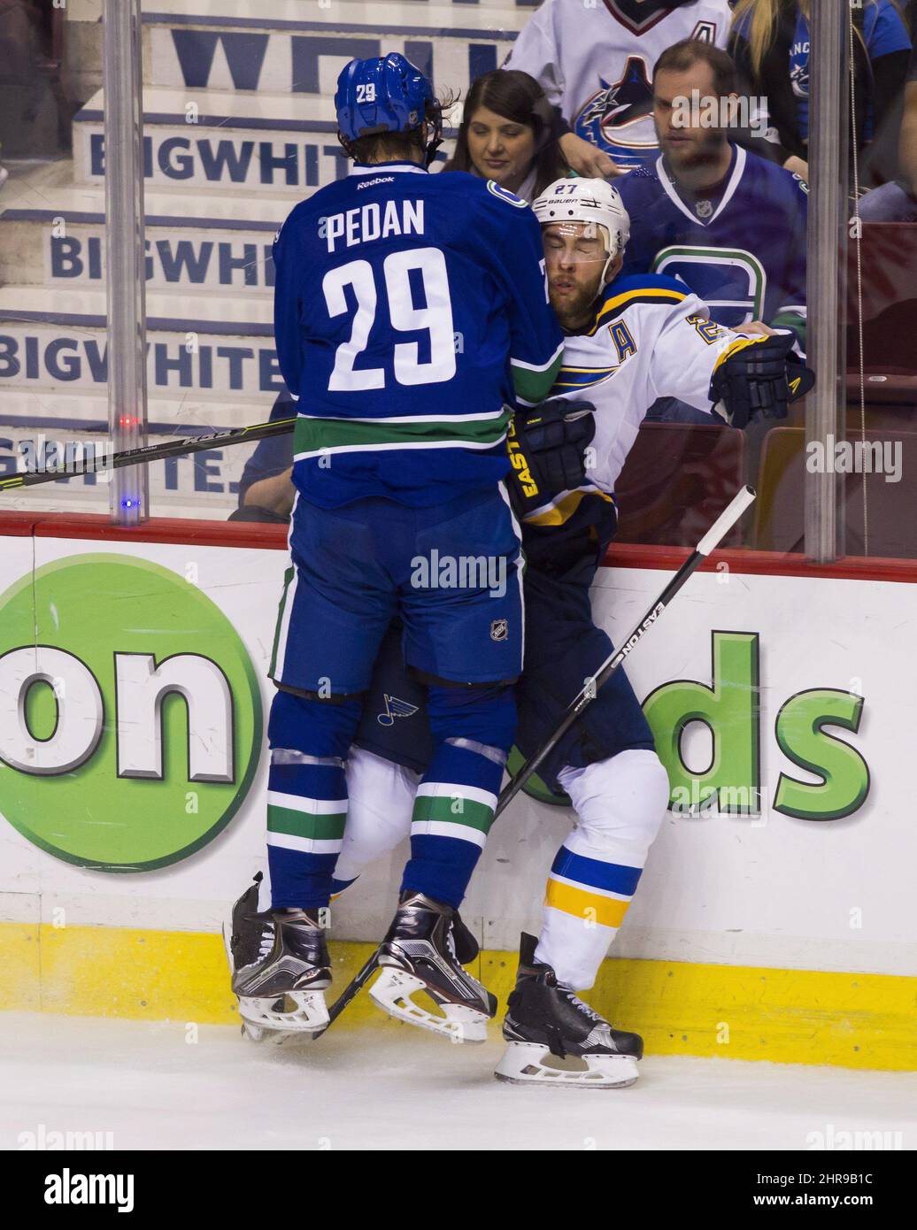 Vancouver Canucks' Andrey Pedan (29) checks St. Louis Blues' Alex ...