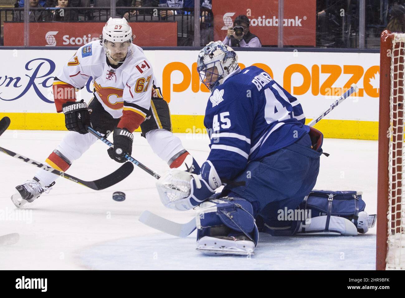 Toronto Maple Leafs goaltender Jonathan Bernier, right, makes a save on ...
