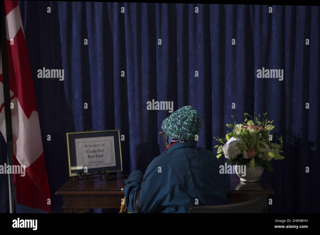 A well wisher writes in a book of condolence at Toronto's city hall on ...