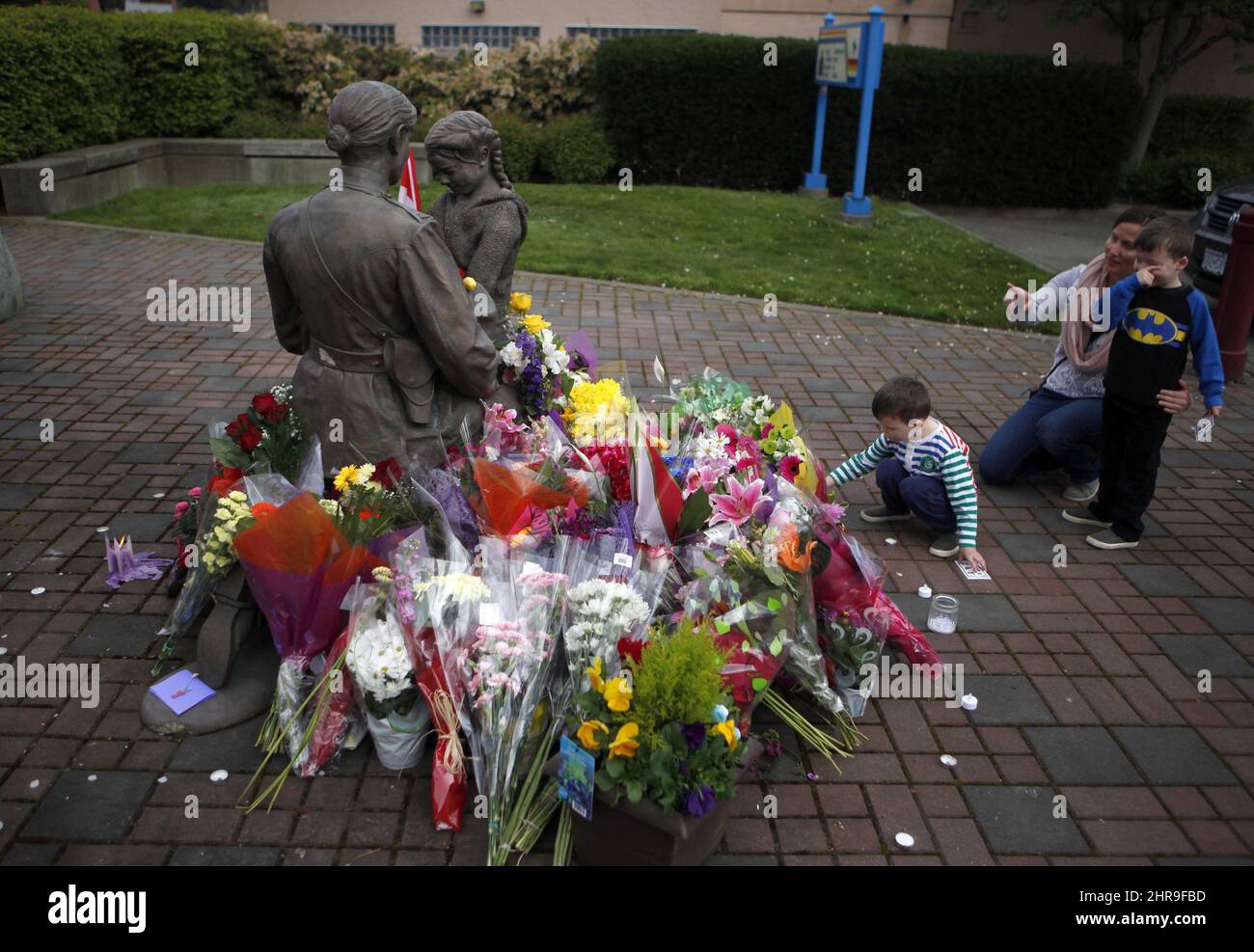 Jillian Oickle and her sons Oliver and Benjamin pay their respects at a ...