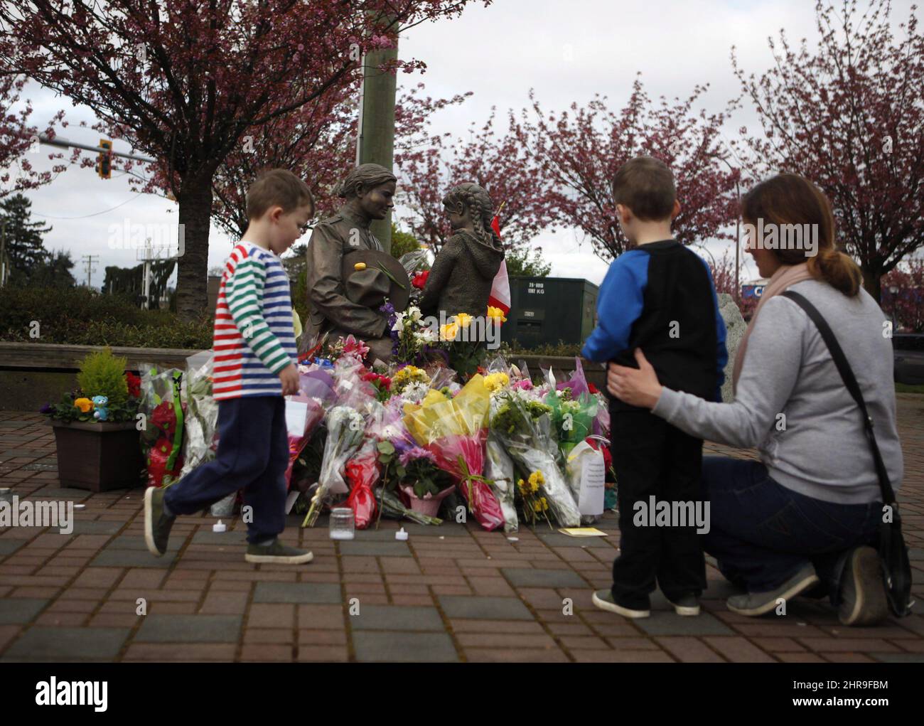 Jillian Oickle and her sons Oliver and Benjamin pay their respects at a ...