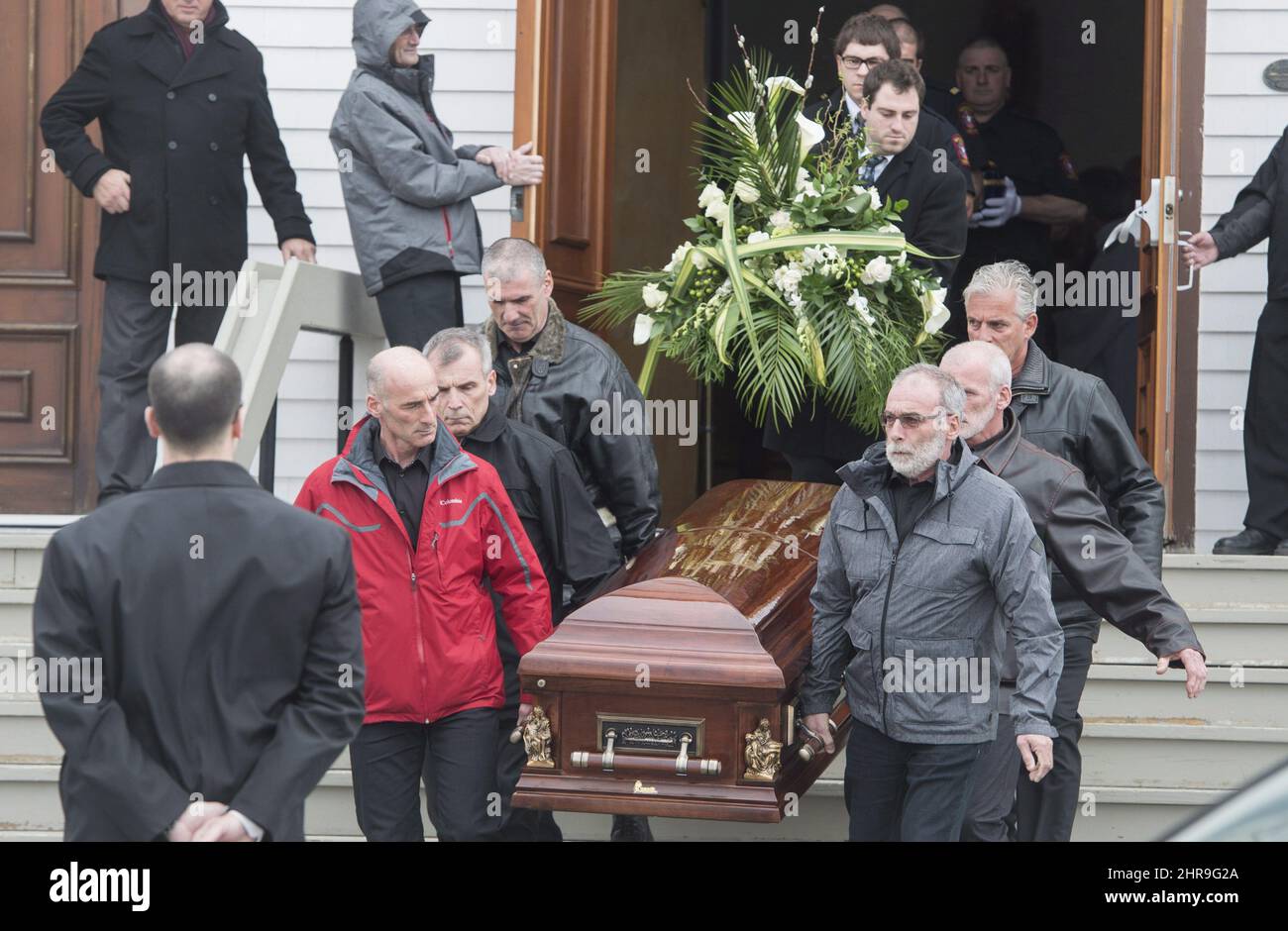 The casket of Jean Lapierre's father Raymond is carried out of church ...