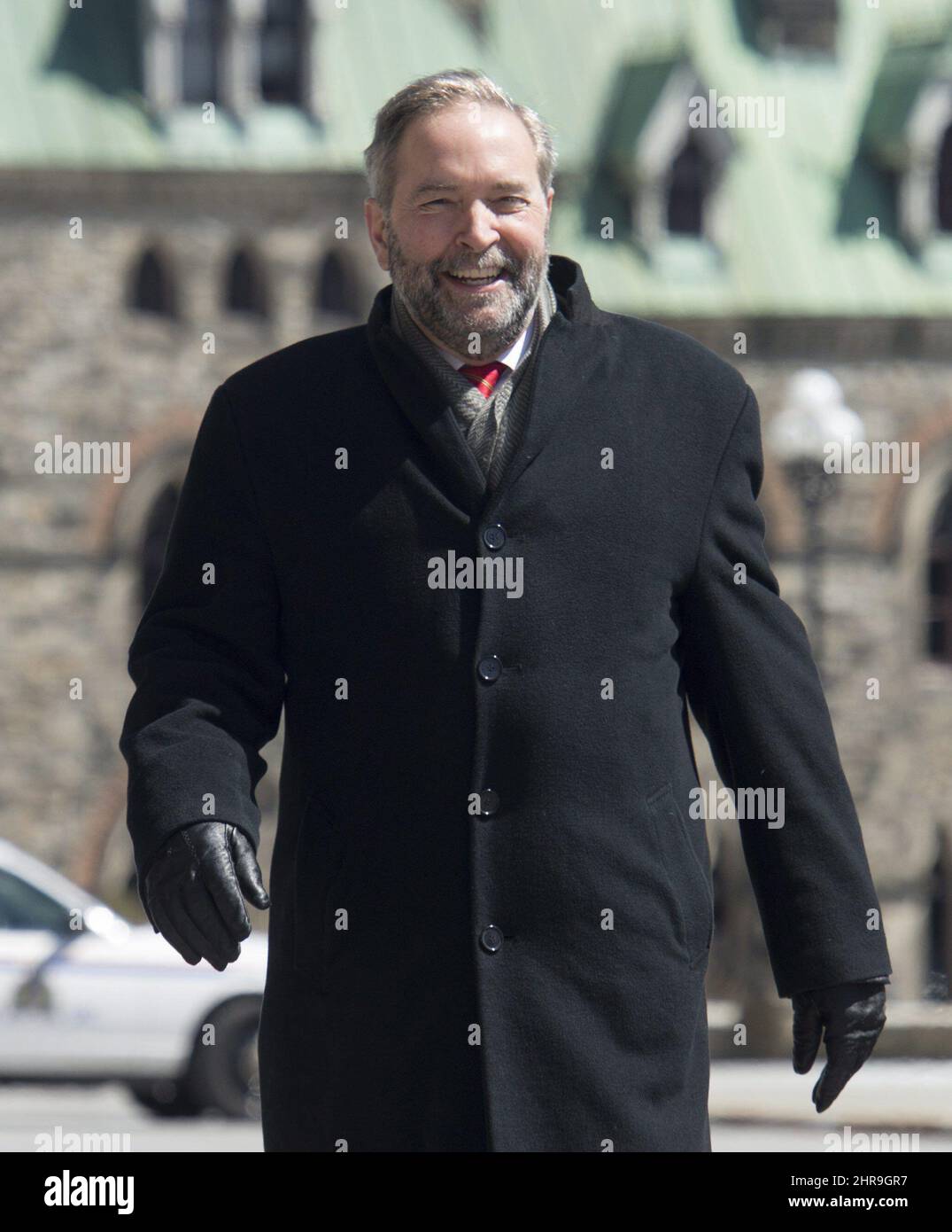 NDP Leader Tom Mulcair walks to Parliament Hill following party caucus ...