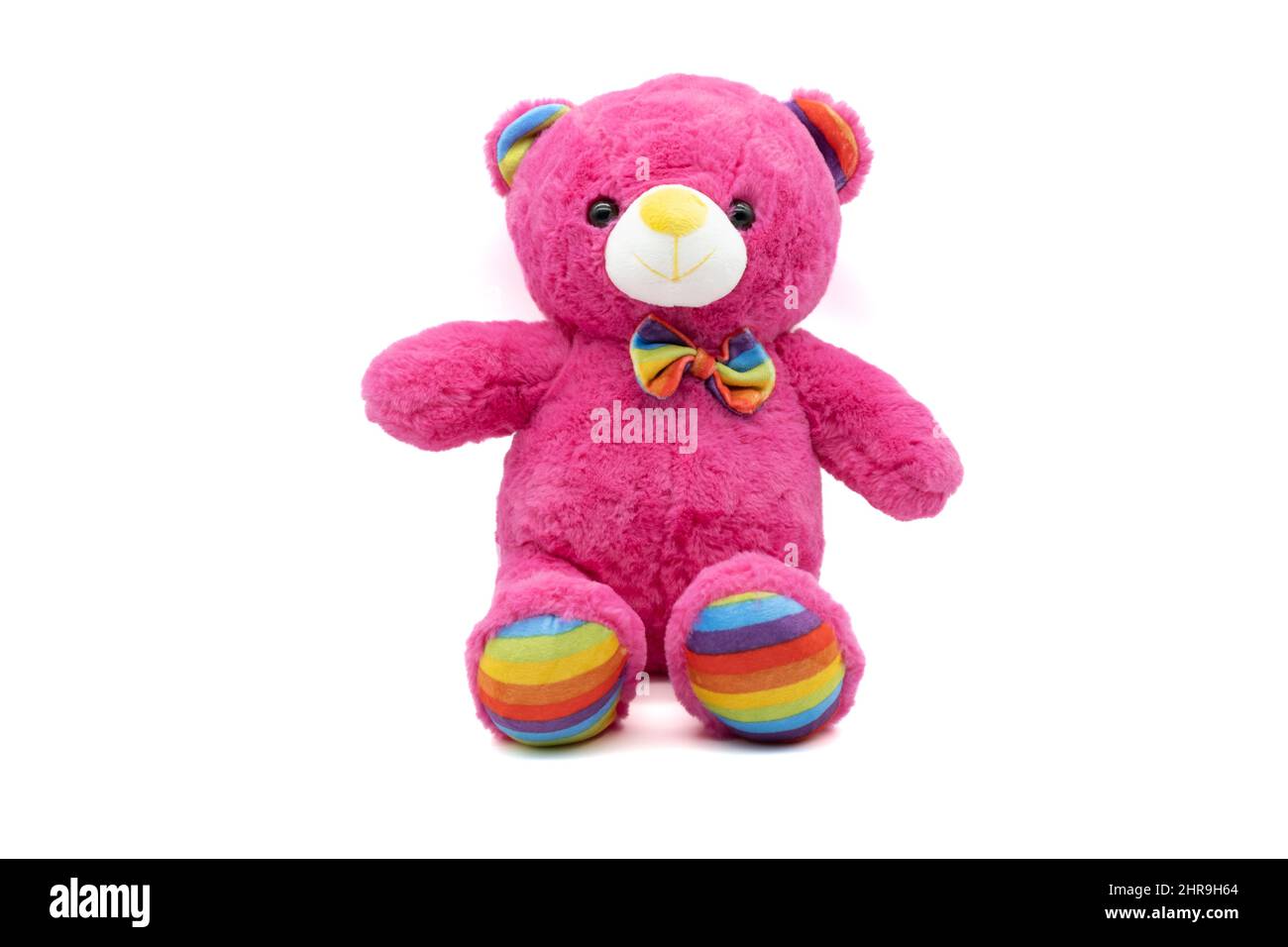 a miniature figure of a small pink teddy bear isolated with white ...