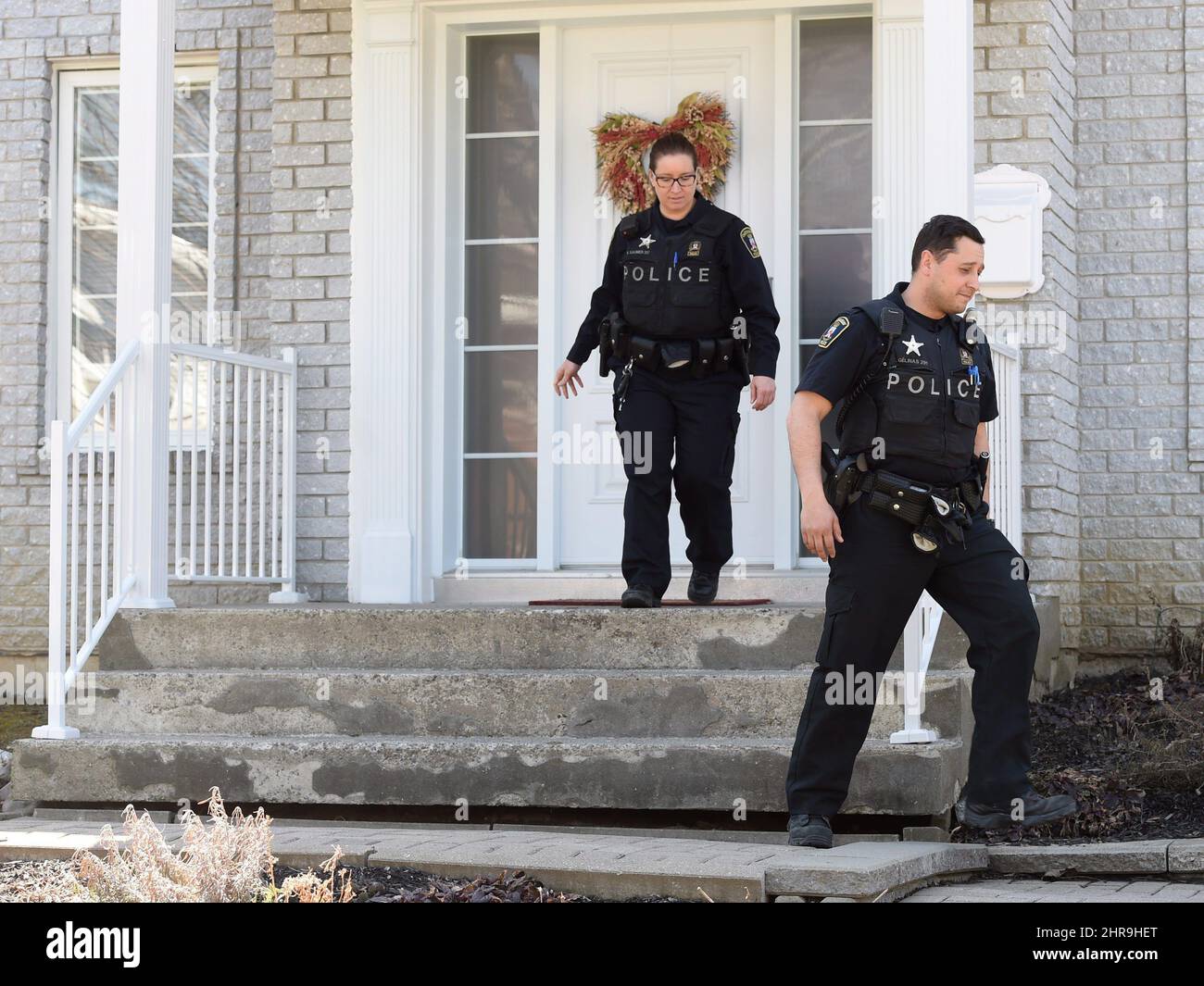 Police officers leave a house where convicted killer Karla Homolka ...