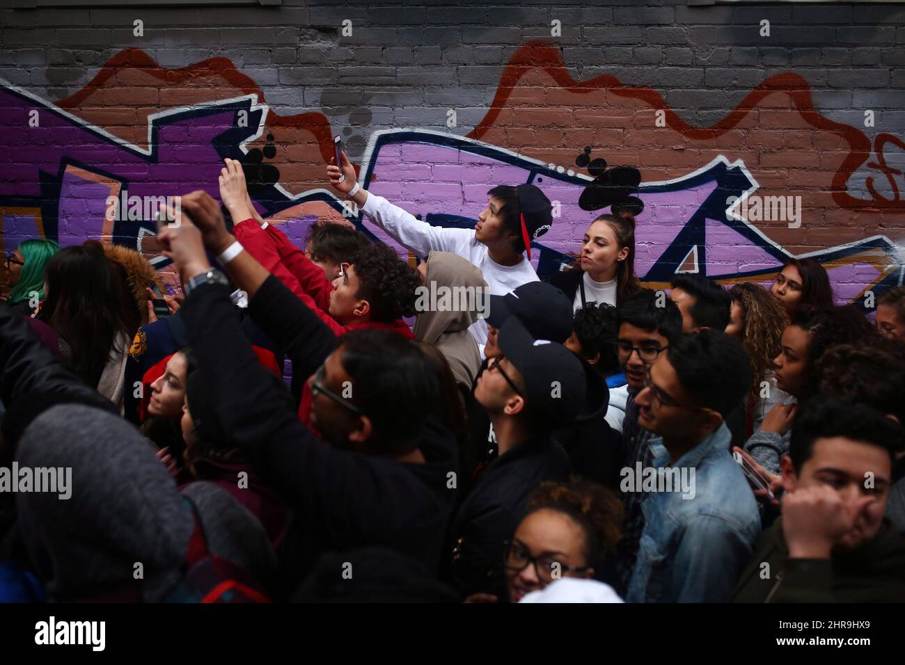 Fans take photos of Toronto rapper Drake as he appears in his pop up ...
