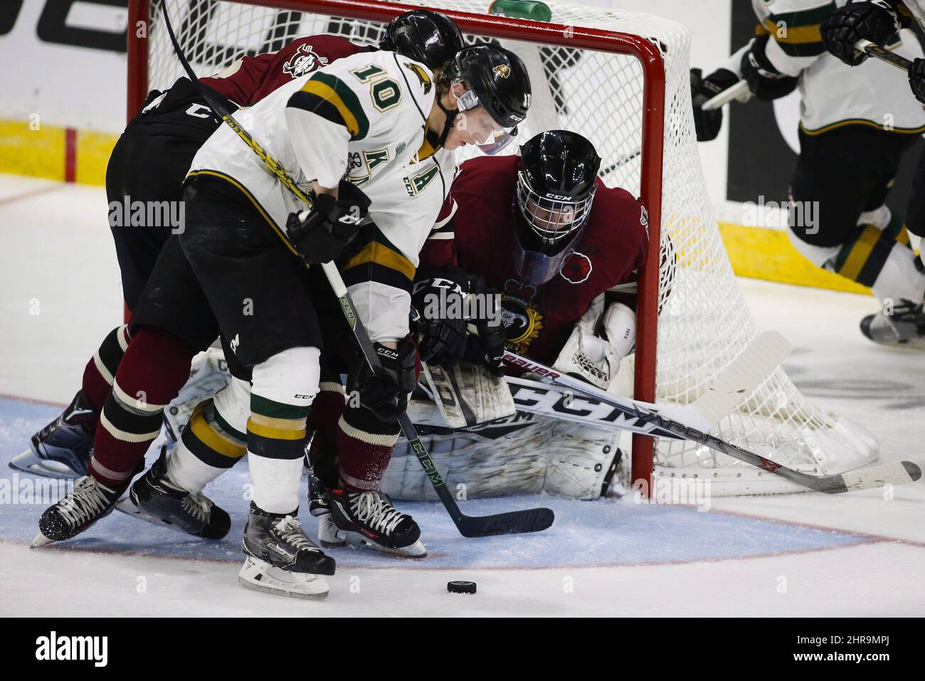 London Knights' Christian Dvorak, left, struggles to get the pusk past ...