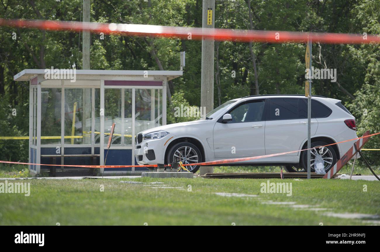 A white luxury SUV with a broken passenger-side window is shown at the ...