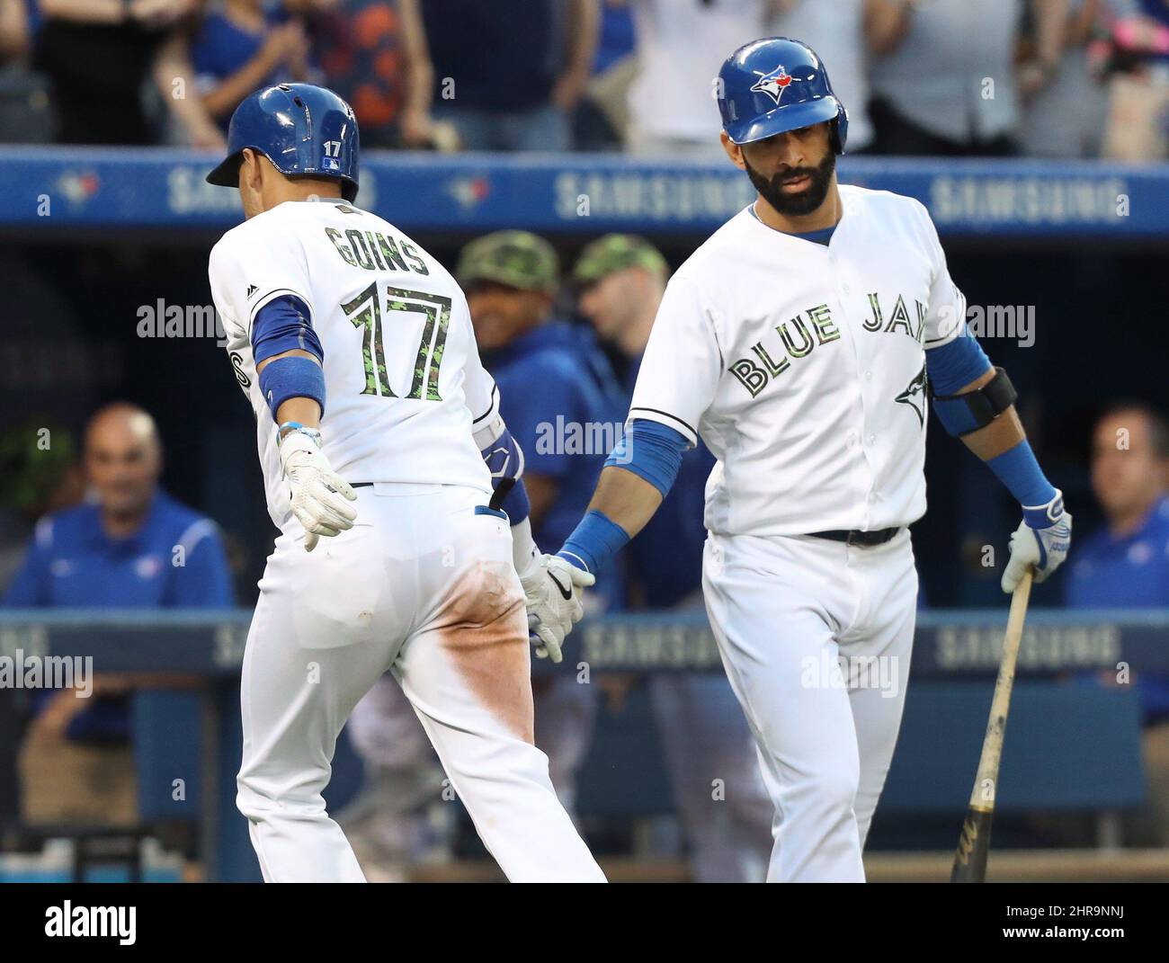Toronto Blue Jays' Ryan Goins is congratulated by teammate Jose ...