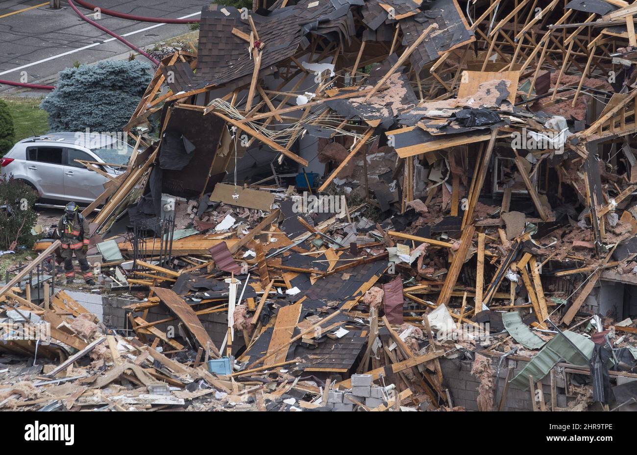 A firefighter walks on the scene of a house explosion in Mississauga ...