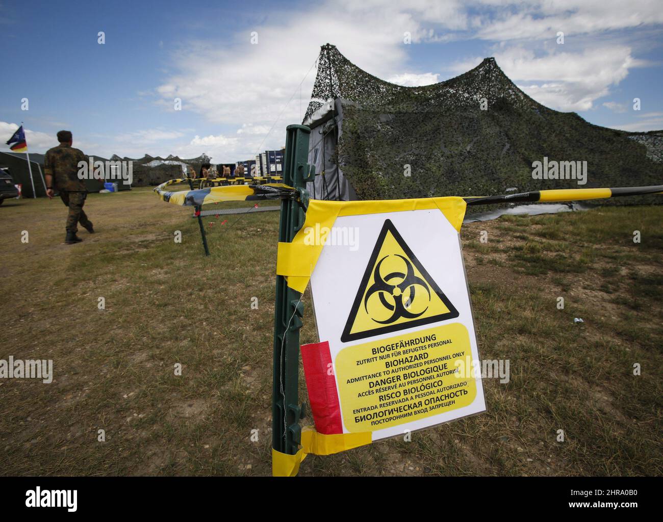 A bio-hazard warning sign outside a portable lab during NATO Exercise ...