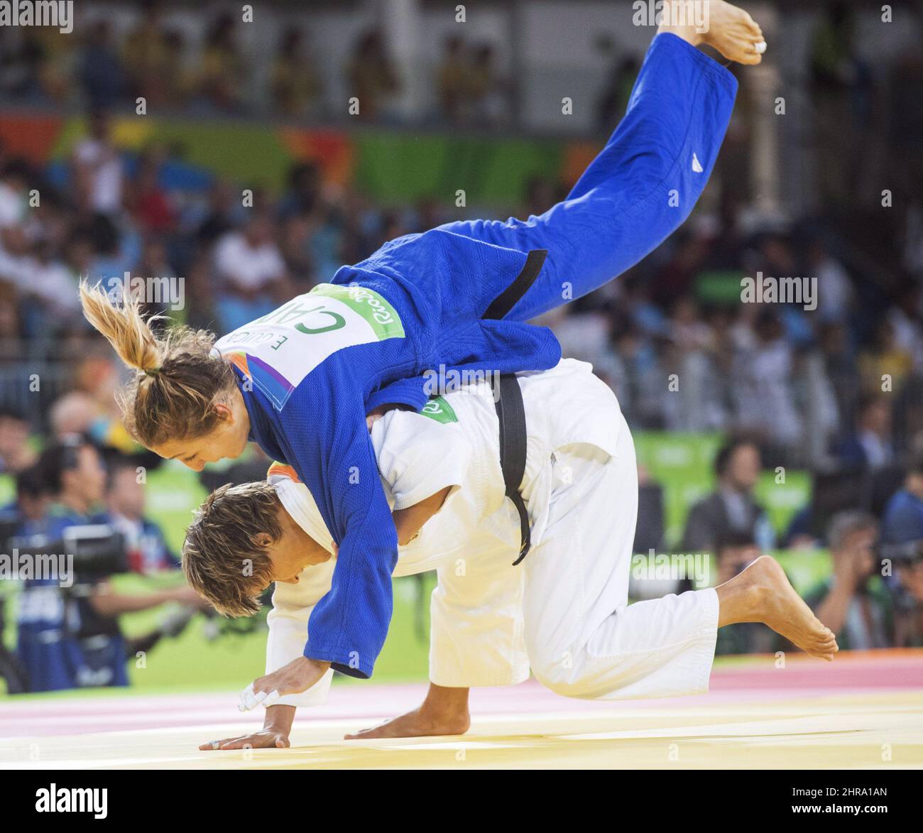 Canada's Ecaterina Guica, top, from LaPrairie, Que., is flipped by ...