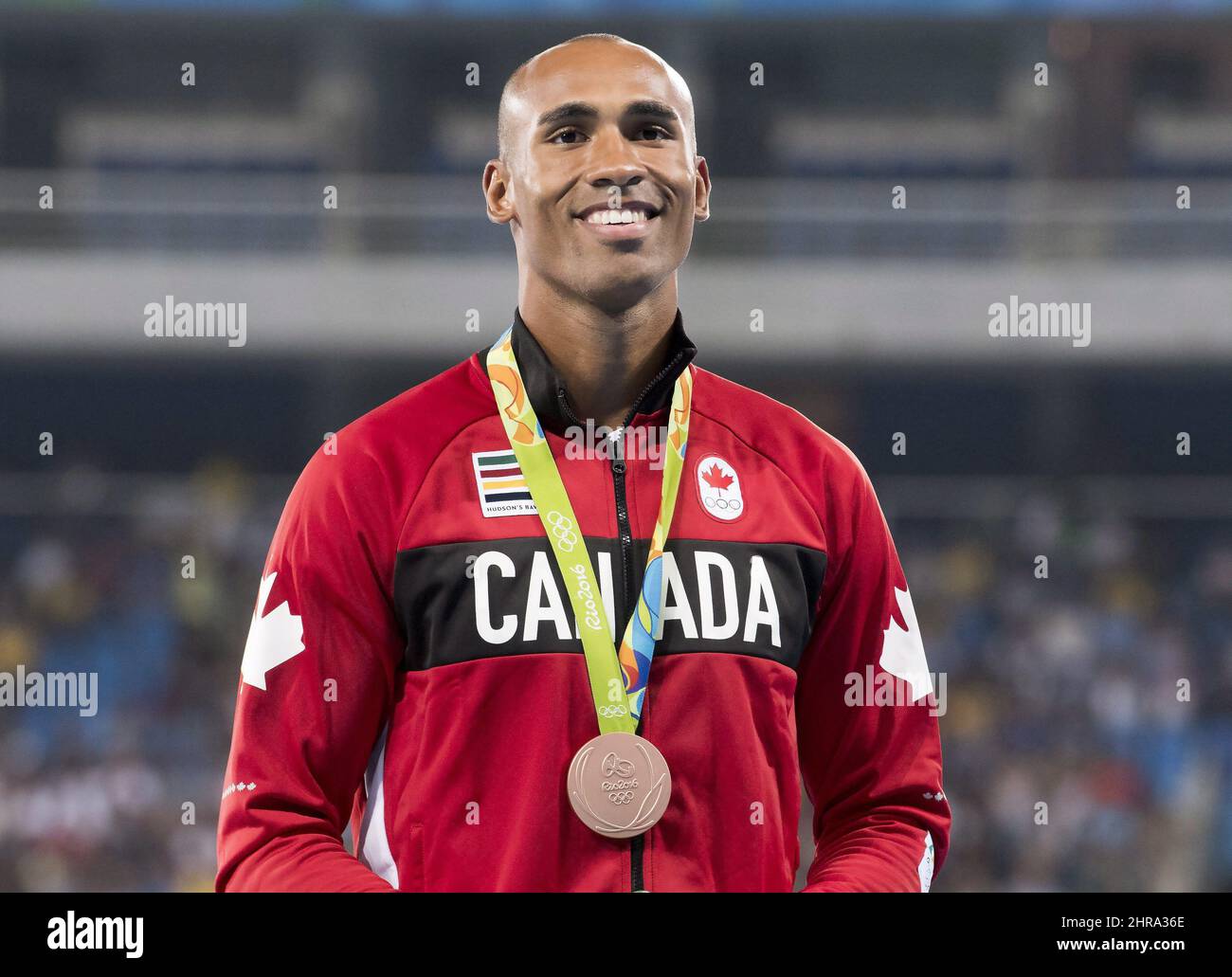 Canada's Damian Warner stands on the medal podium with his bronze medal ...