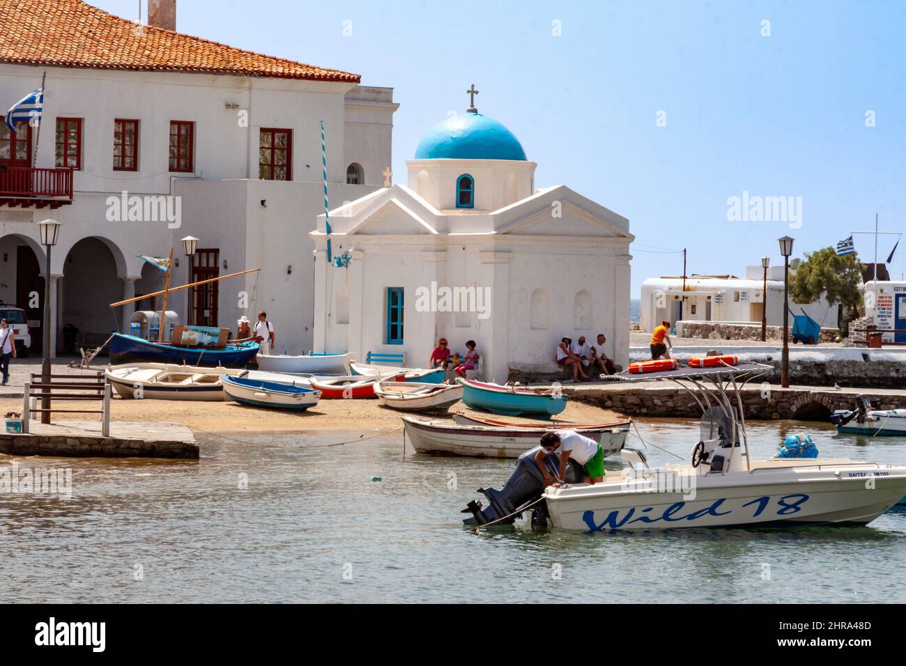 View of boats and a typical white church in Mykonos Island, Greece ...