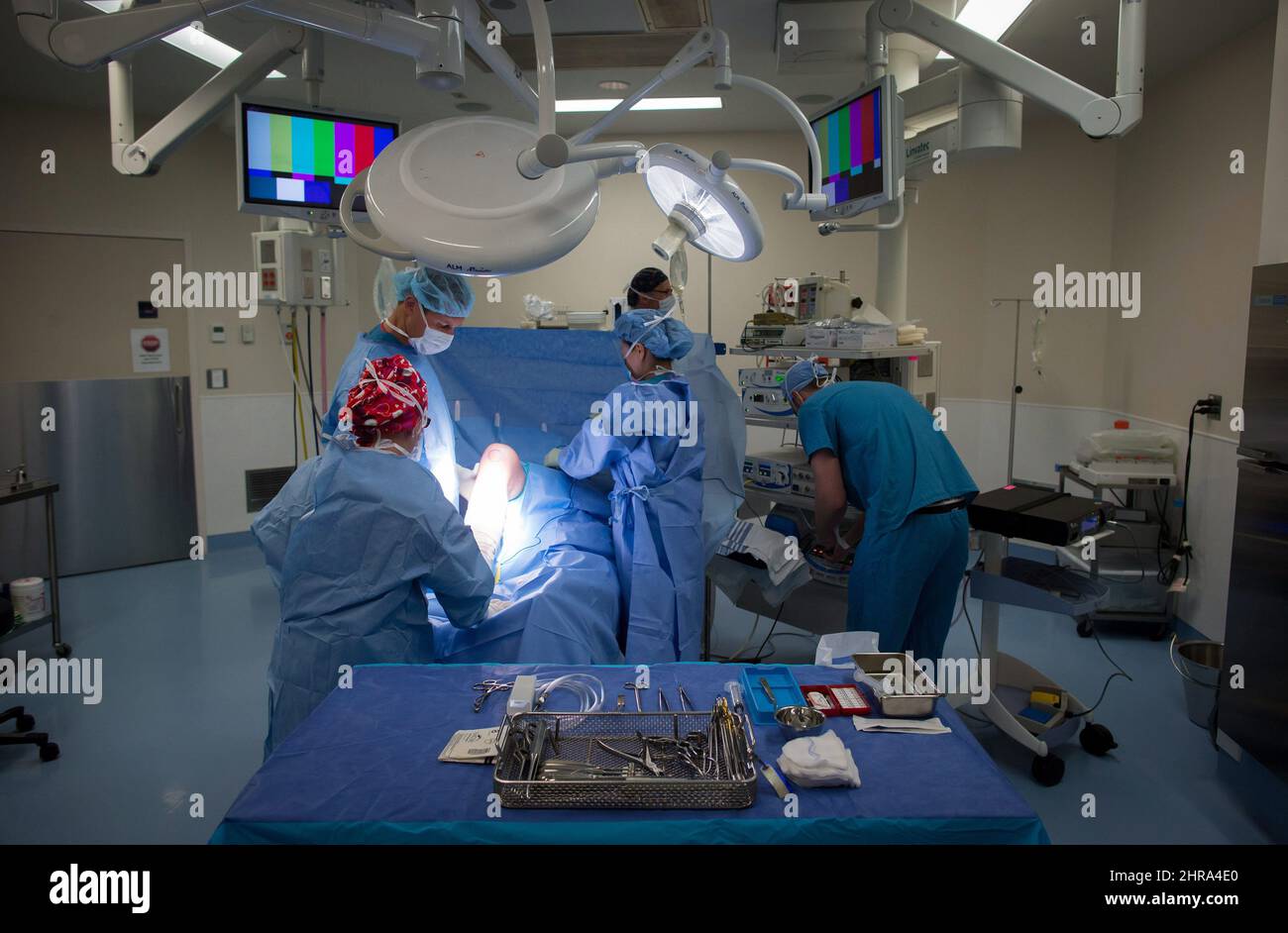 A male patient is prepped to have a cyst removed from his right knee at ...