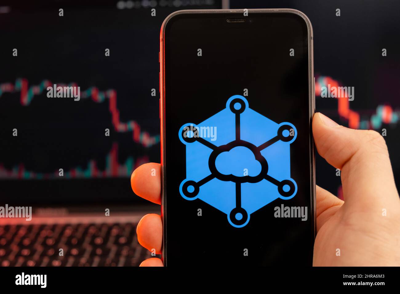 Storj STORJ cryptocurrency logo on the screen of smartphone in mans ...