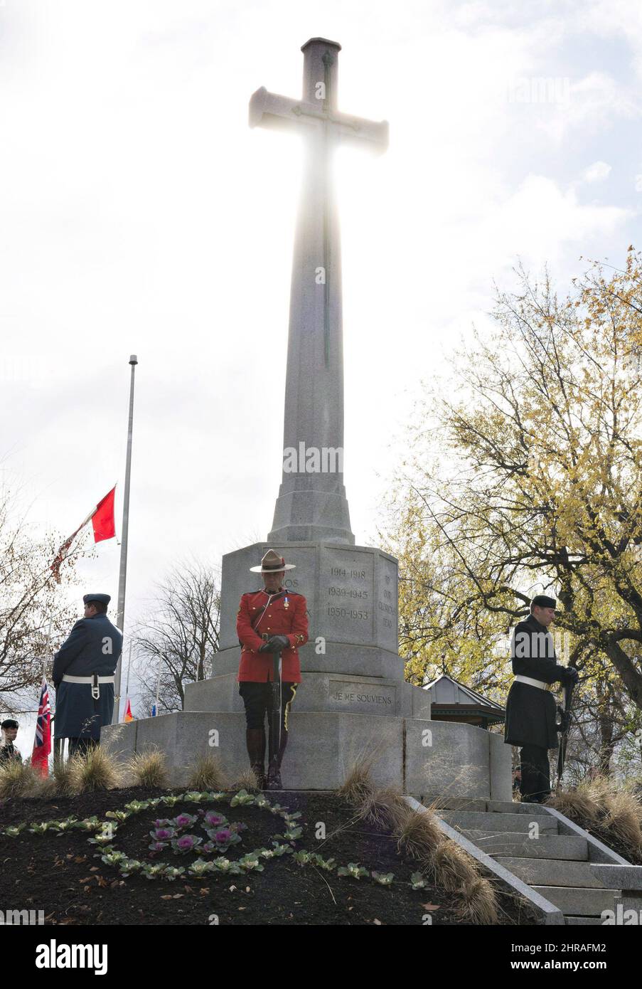 Canadian Armed Forces members and a RCMP officer stand at the Sacrifice ...