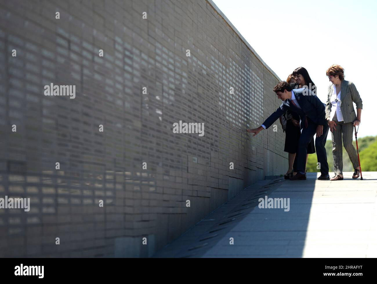 Prime Minister Justin Trudeau walks with Nora Patrich, right, of ...