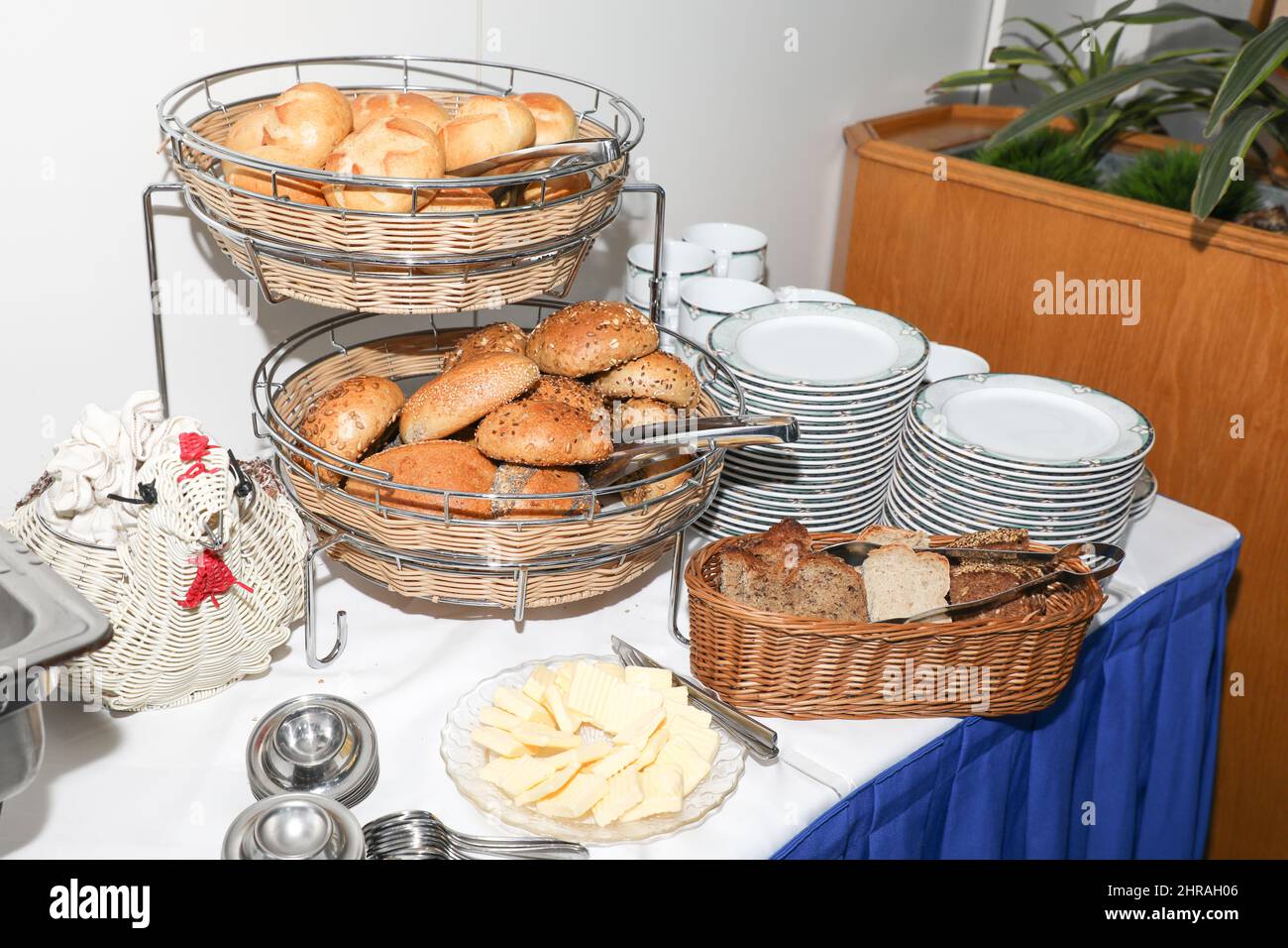 Breakfast buffet table with breads, buuter, and plates Stock Photo - Alamy