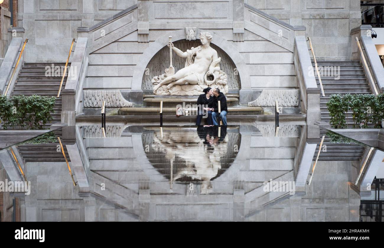 Sarah Cote and Juan Uribe kiss in front of a statue of sea goddess ...